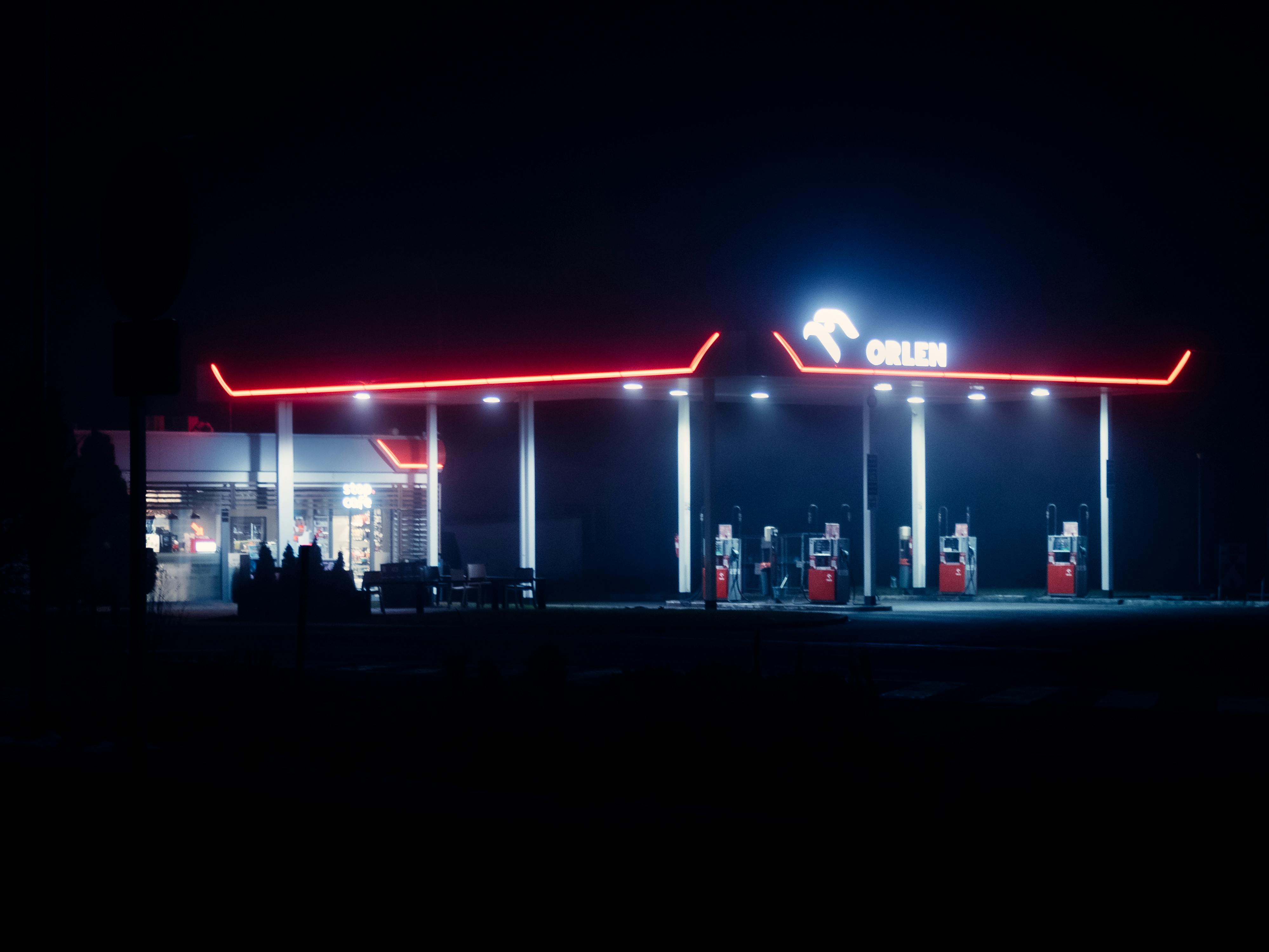 Moody Nighttime Gas Station with Neon Lights · Free Stock Photo