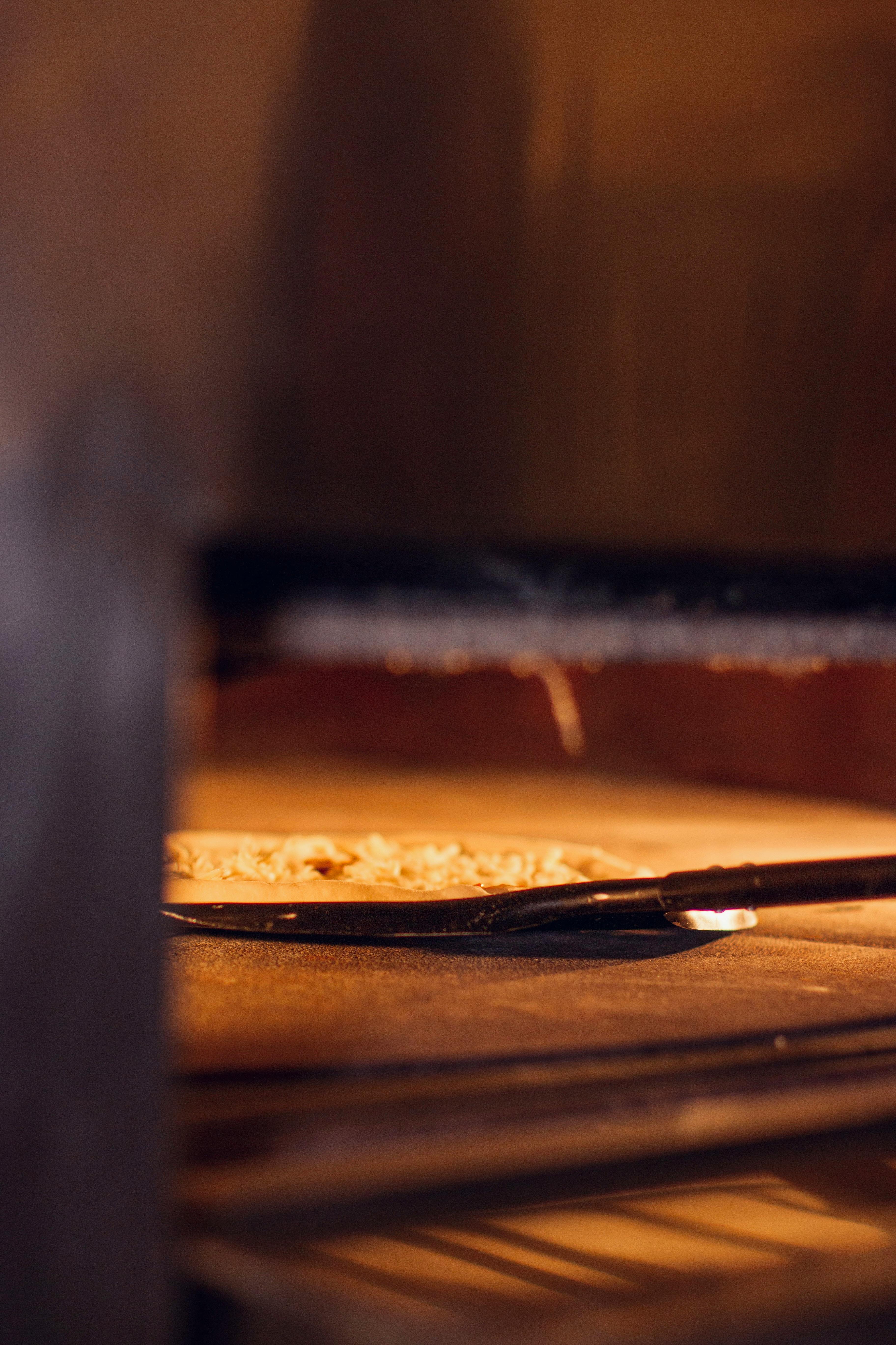 Rustic Pizza Baking in Traditional Oven · Free Stock Photo