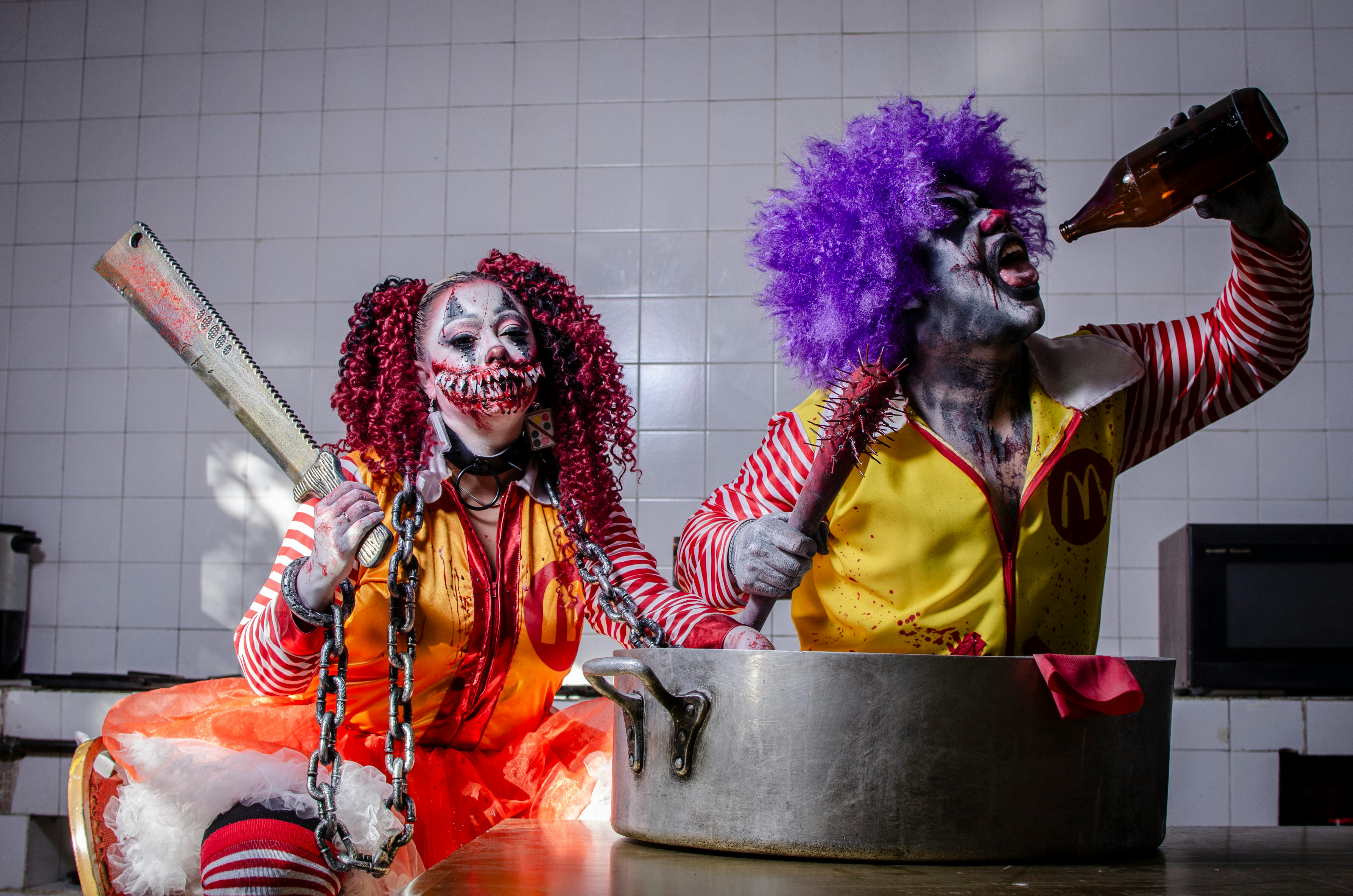 Creepy Clown Cosplay Duo in Kitchen Setting · Free Stock Photo