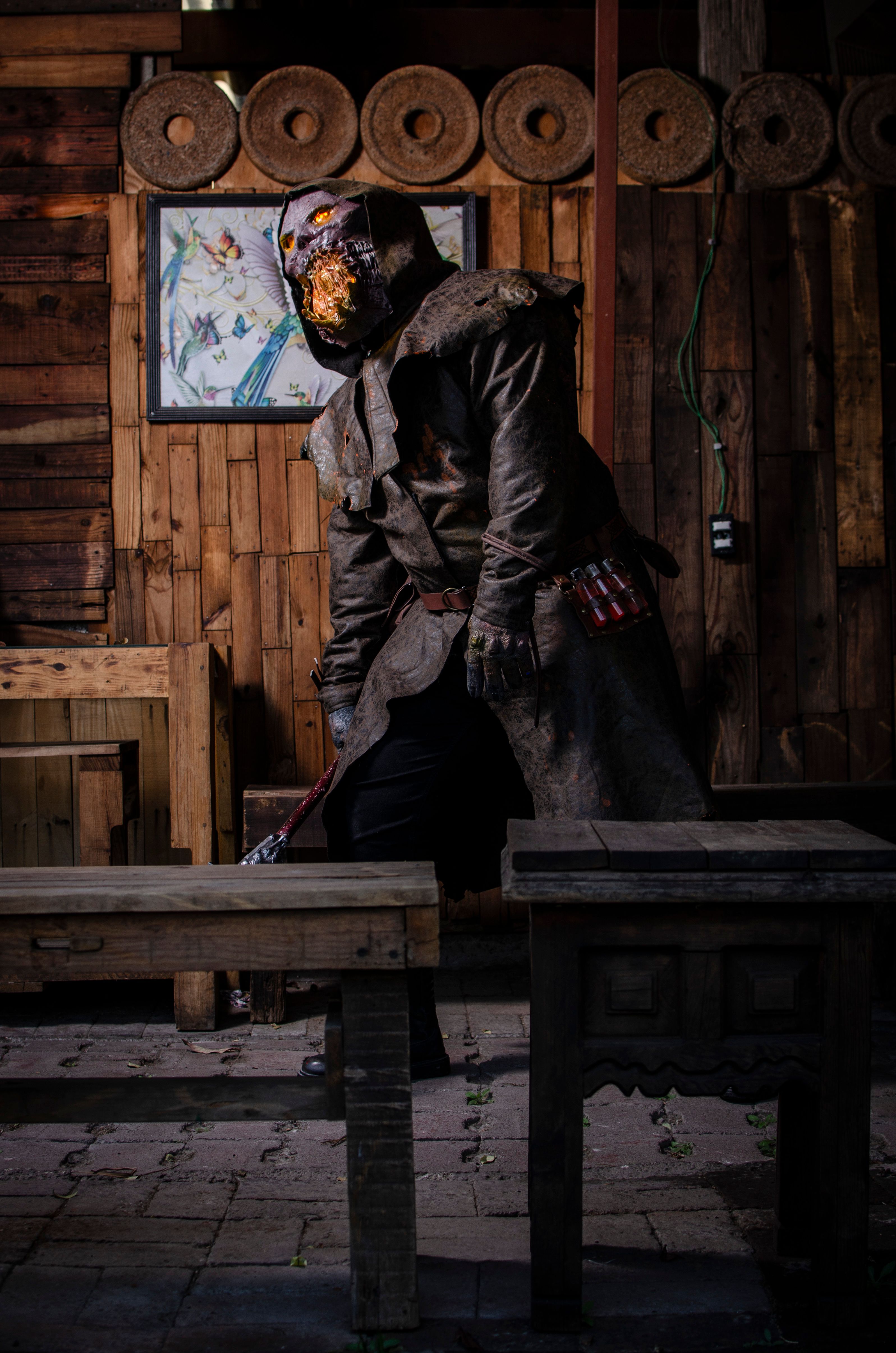 Spooky Masked Figure in Rustic Wooden Setting · Free Stock Photo