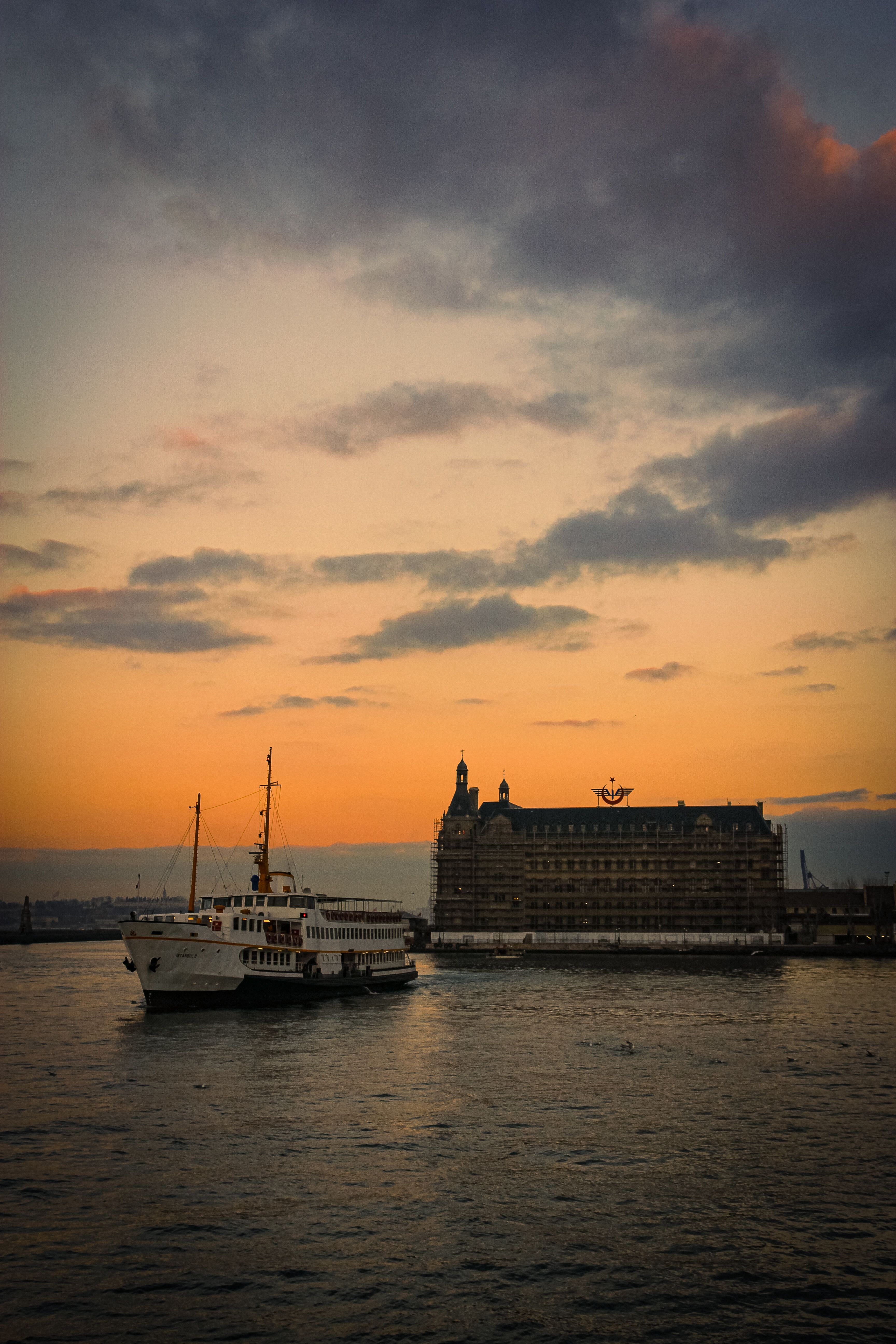 Passenger Ferry at Sunset by Historic Building · Free Stock Photo