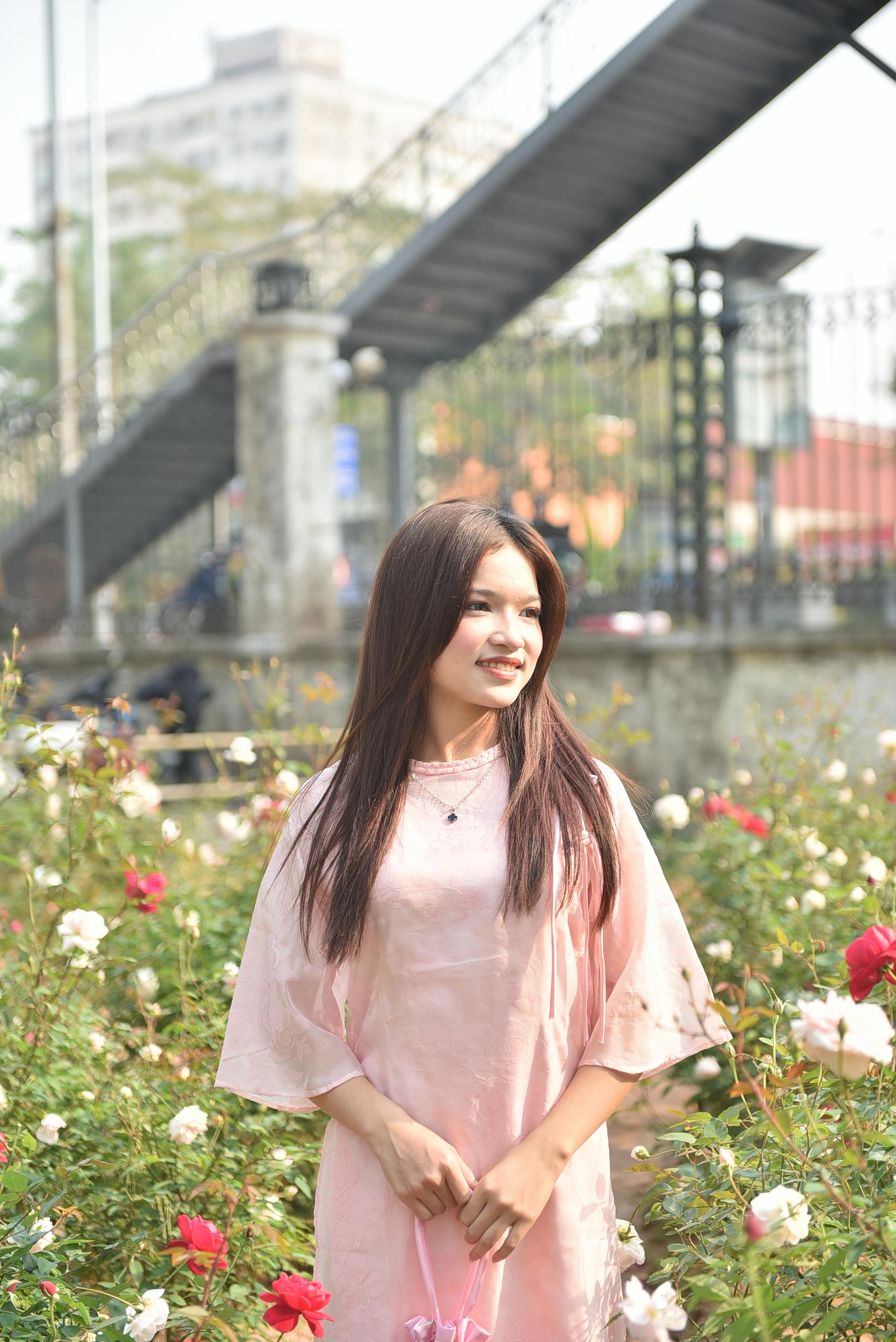 Young Woman in a Rose Garden with Bridge · Free Stock Photo