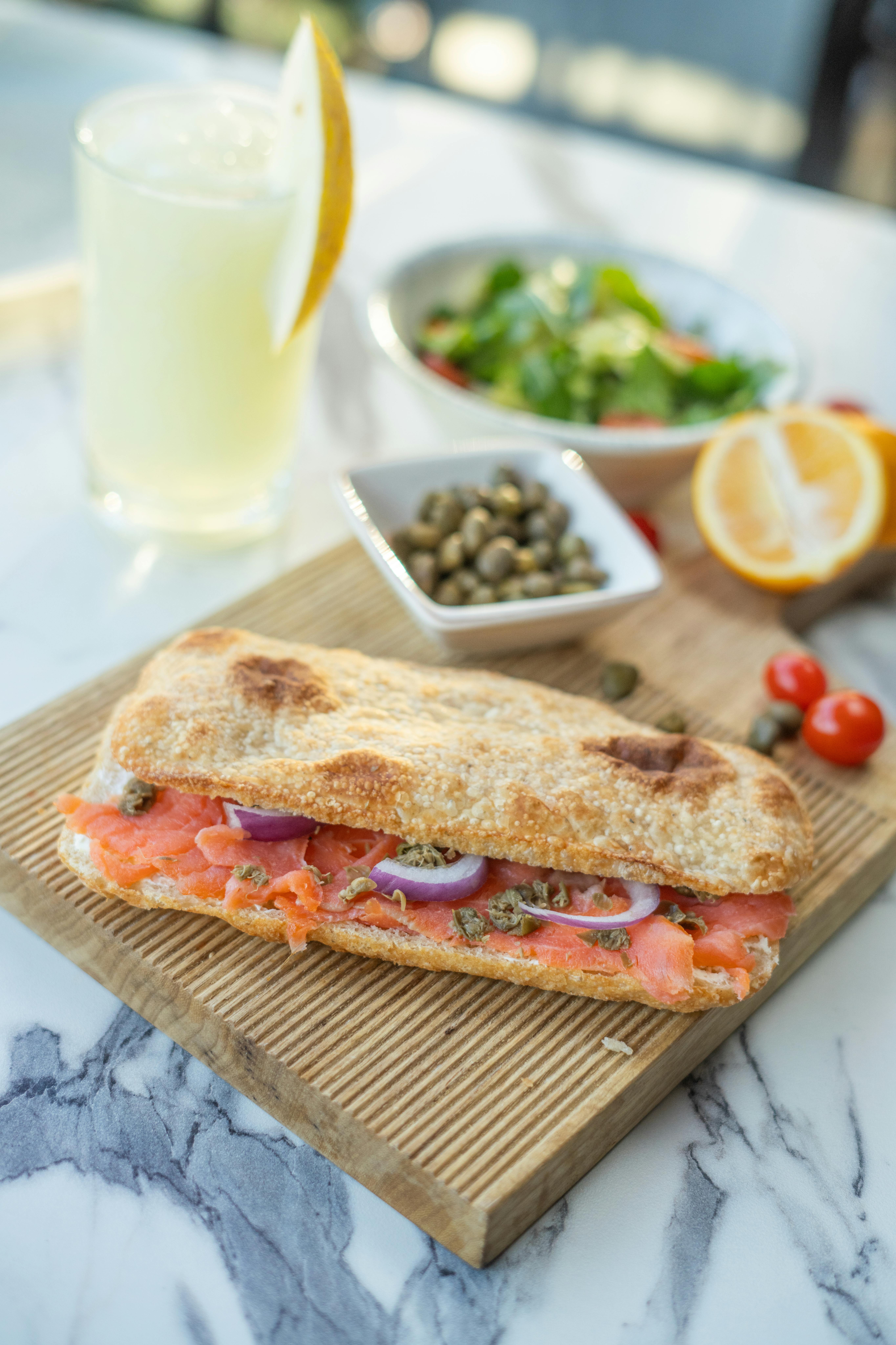 Gourmet Salmon Sandwich with Lemonade and Salad · Free Stock Photo