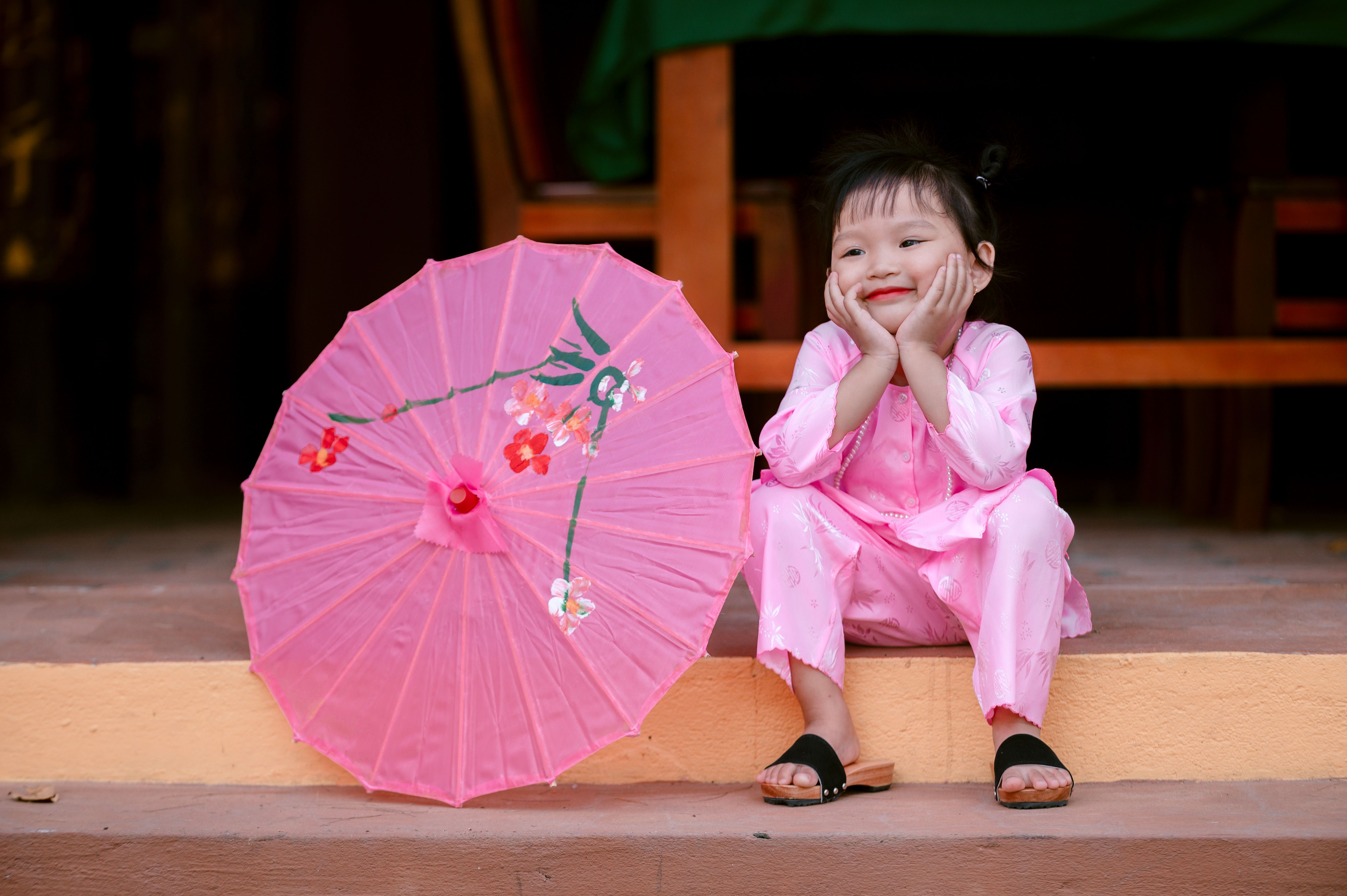 Adorable Child in Traditional Pink Attire · Free Stock Photo