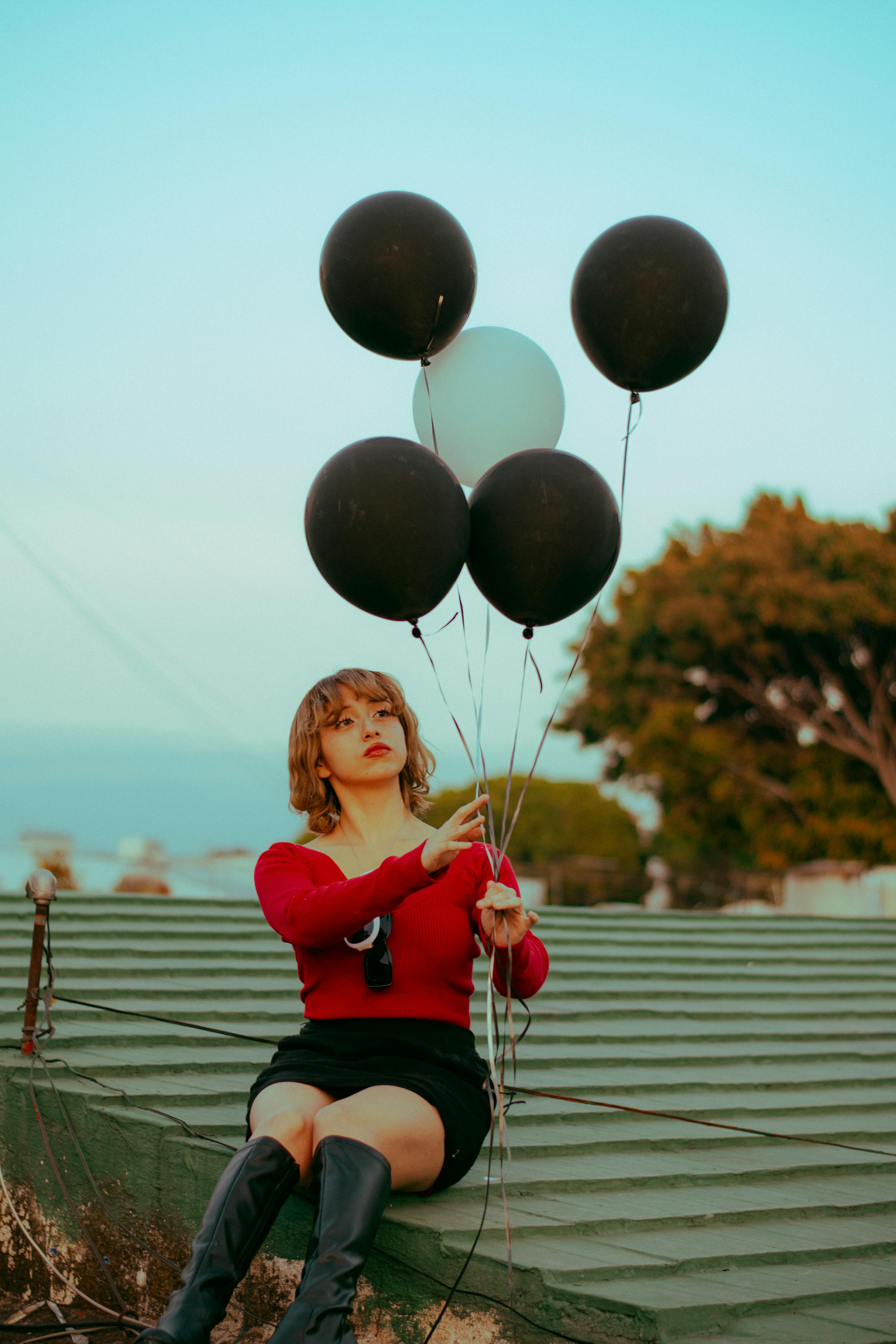 Woman with Balloons on Rooftop in Casual Setting · Free Stock Photo