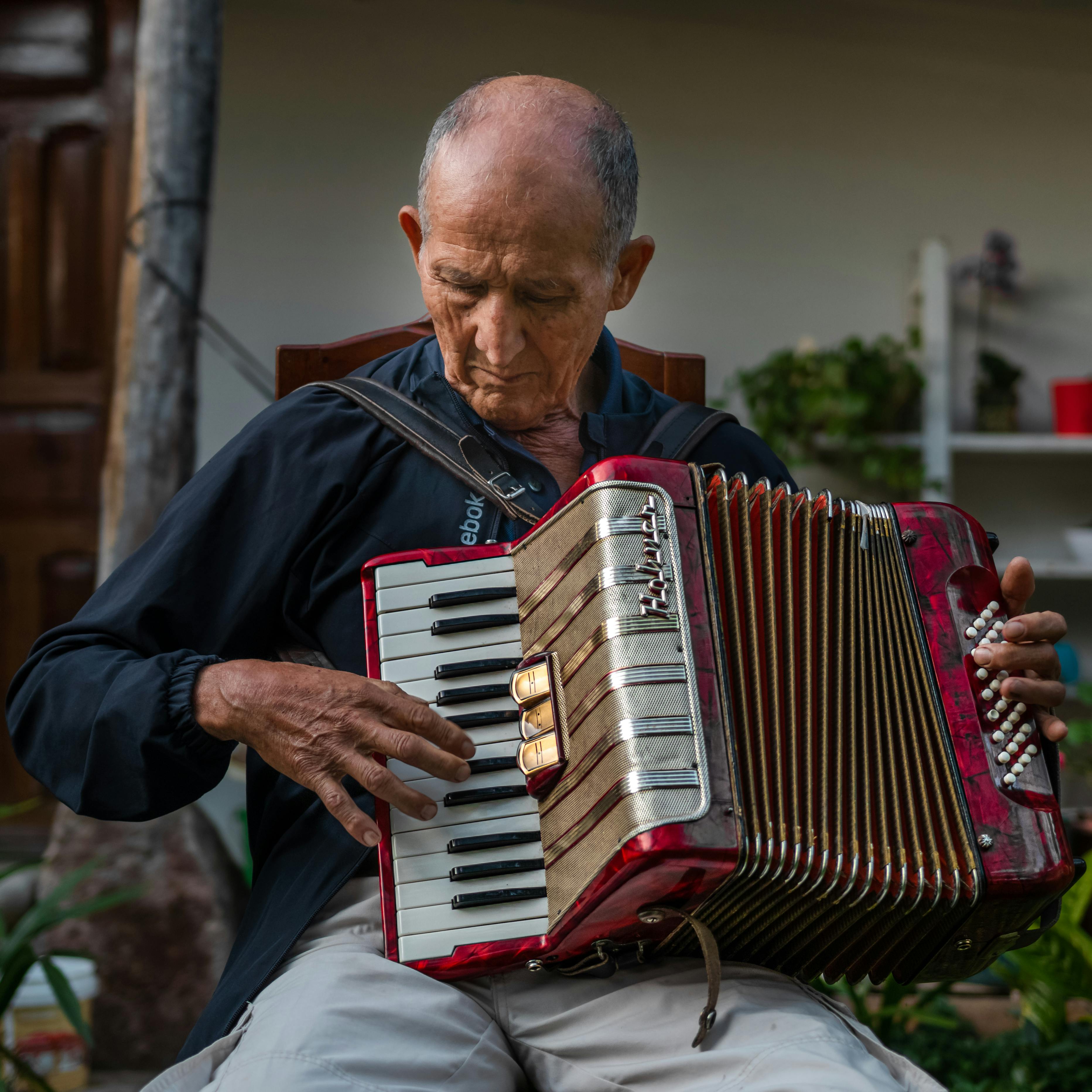 Elderly Man Playing Accordion Outdoors in Jaén · Free Stock Photo