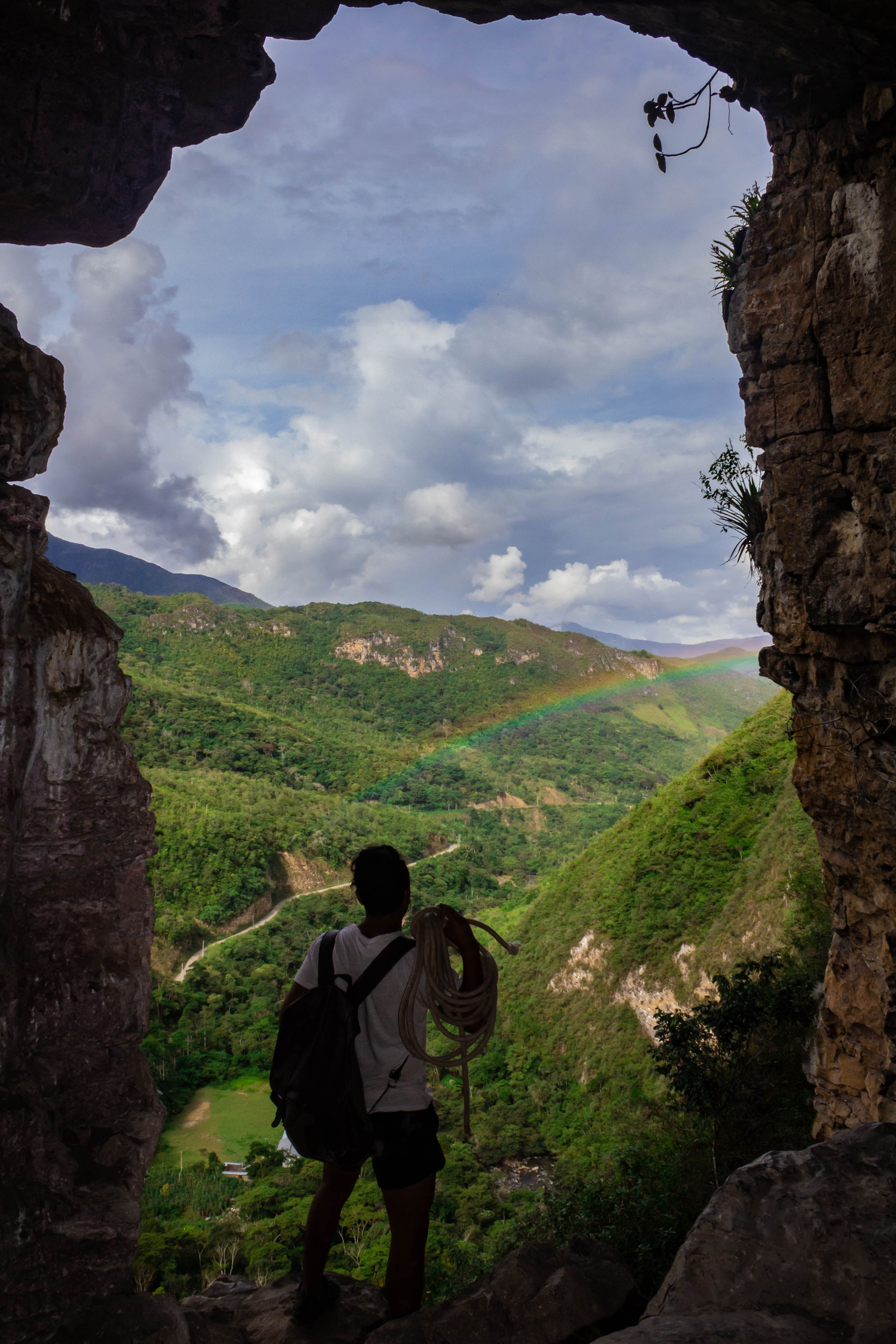 Adventurous Hiker in Amazon Cave with Rainbow · Free Stock Photo
