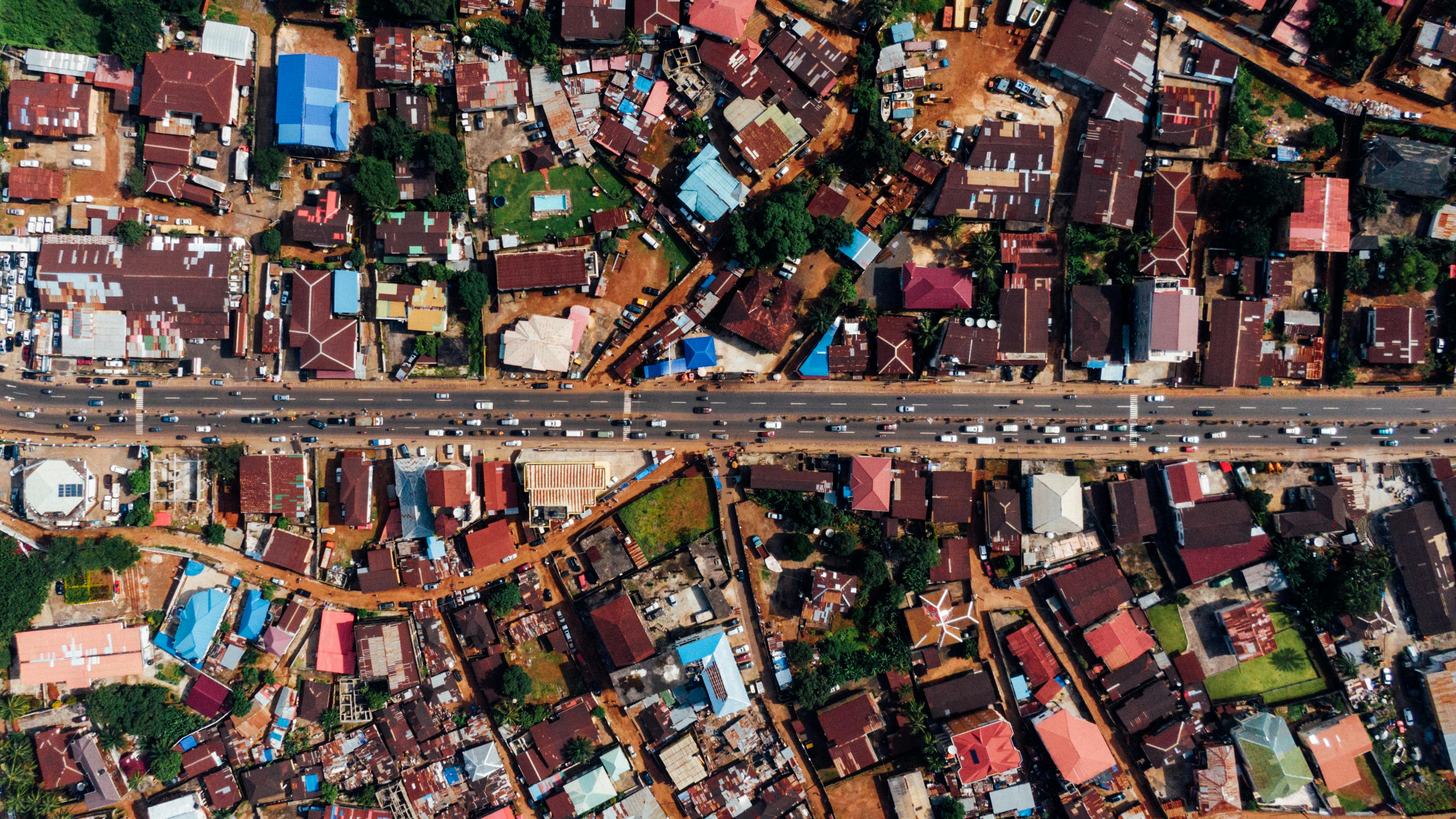 Aerial Photography of Road Between Houses · Free Stock Photo