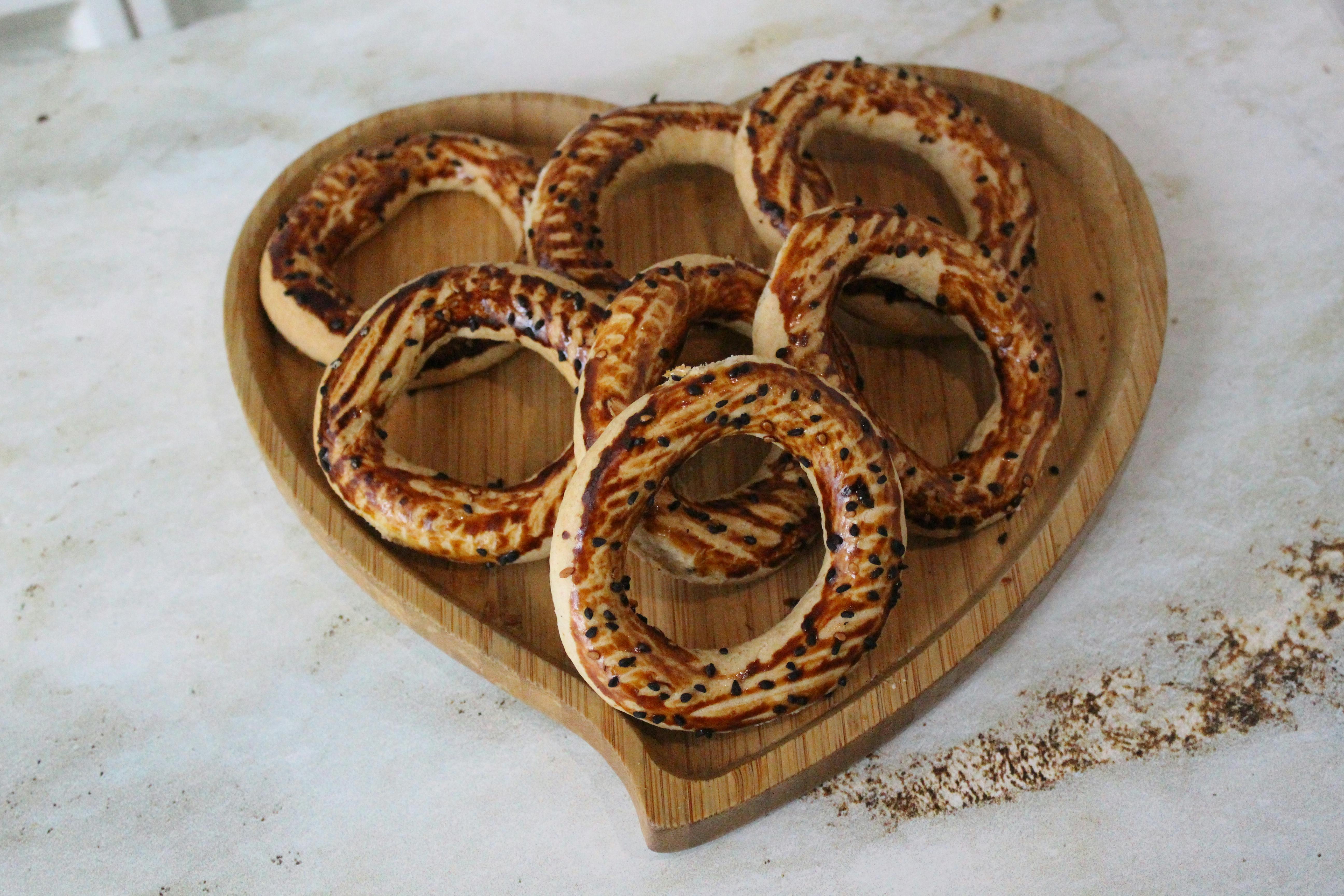 Traditional Turkish Simit on Wooden Heart-Shaped Plate · Free Stock Photo