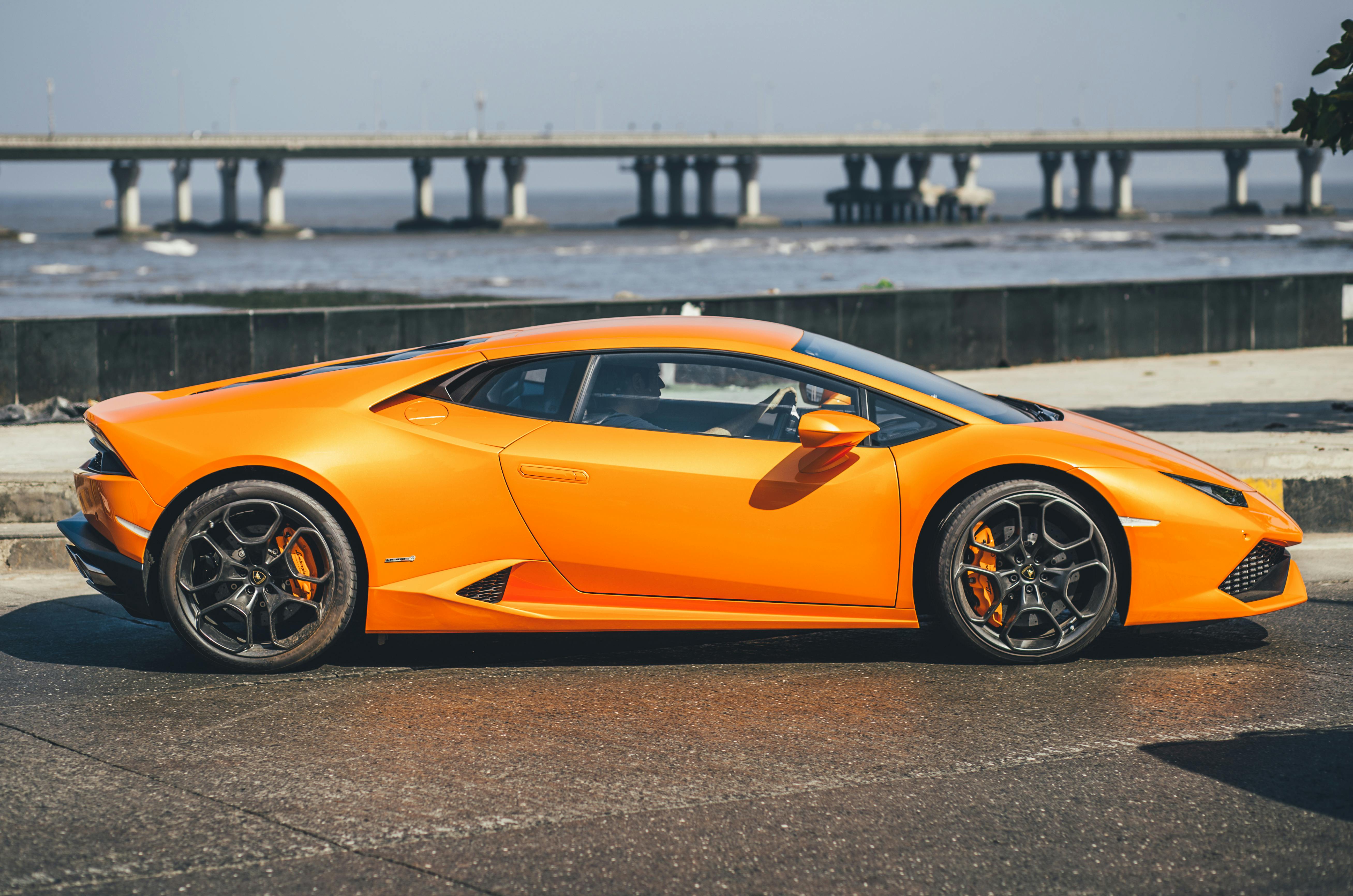 Orange Lamborghini Huracan Parked by Mumbai Sea Link · Free Stock Photo