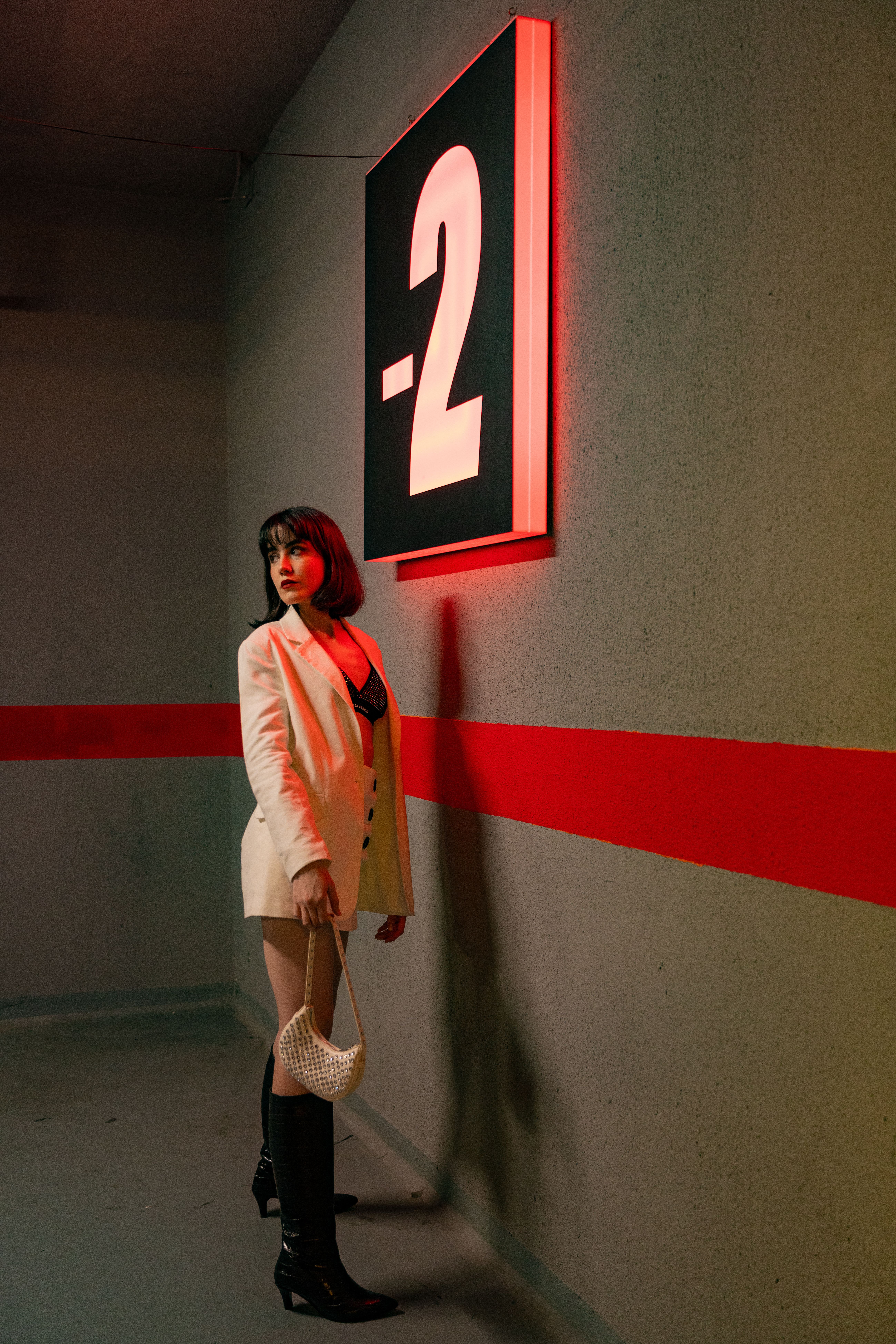 Trendy Woman in Garage with Stylish Outfit · Free Stock Photo