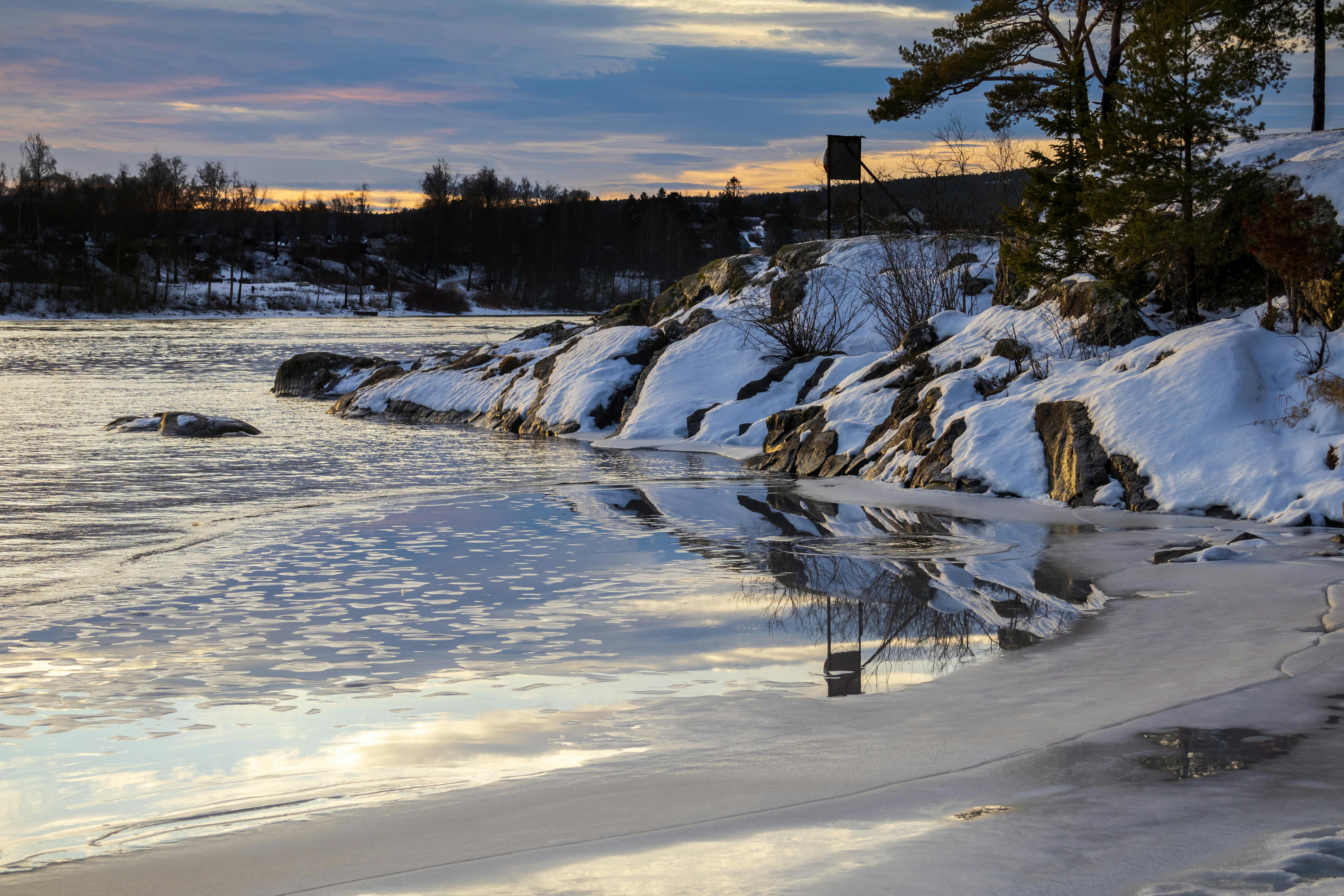 Serene Winter Sunset Over Icy River · Free Stock Photo