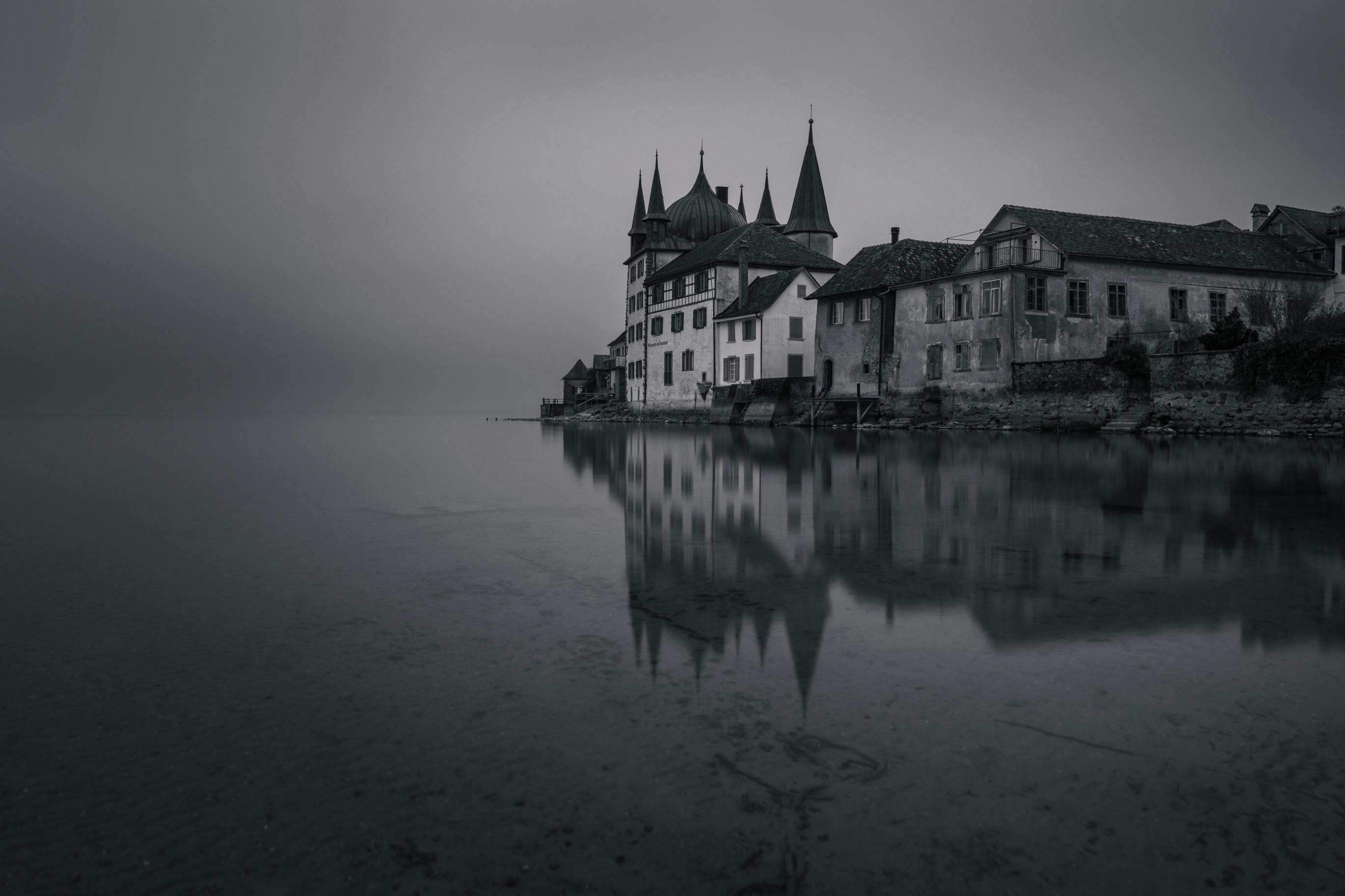 Moody Castle Reflection on Tranquil Lake · Free Stock Photo