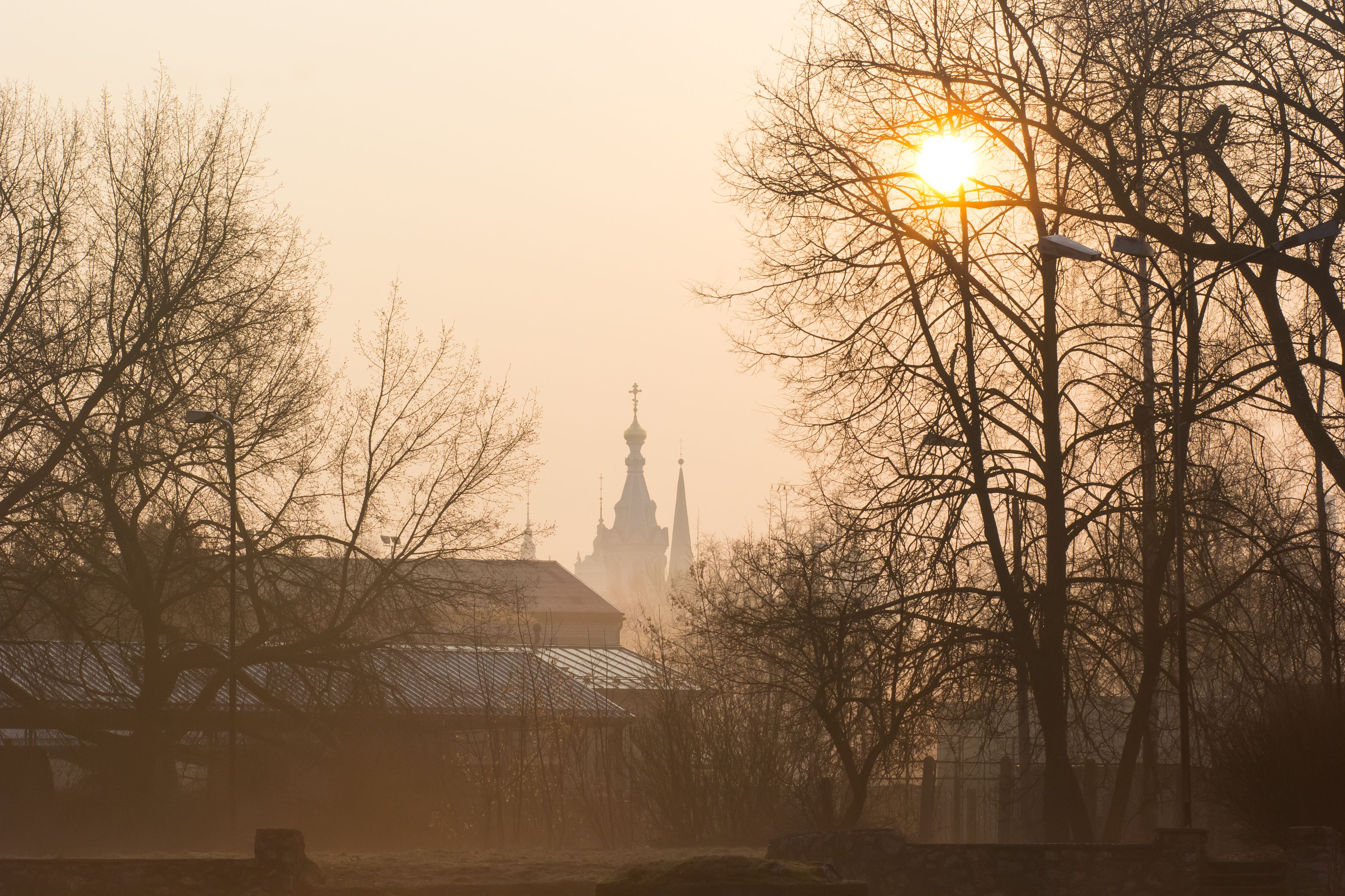 Serene Sunrise over a Misty Church Skyline · Free Stock Photo
