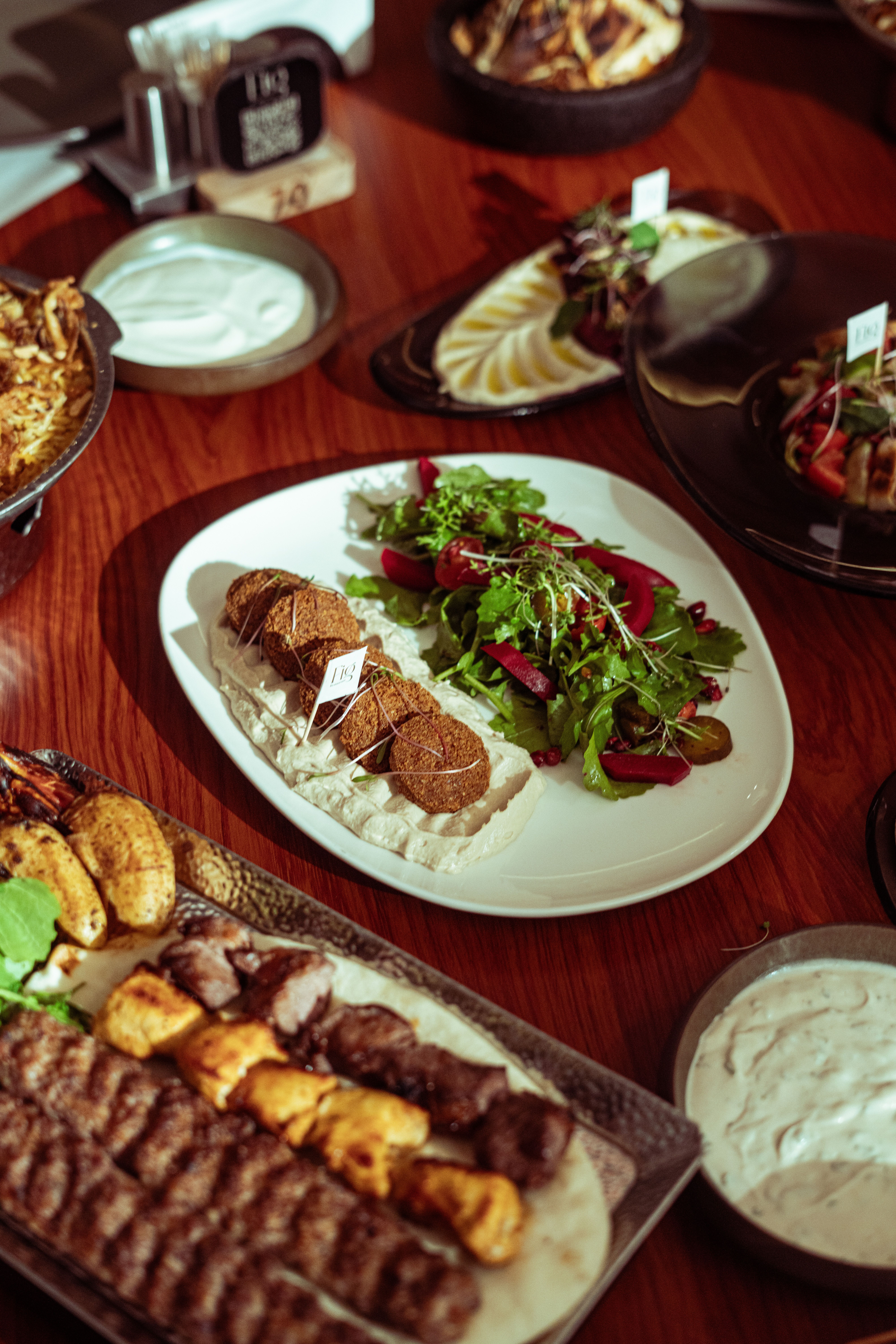 Authentic Iraqi Cuisine on a Wooden Table · Free Stock Photo