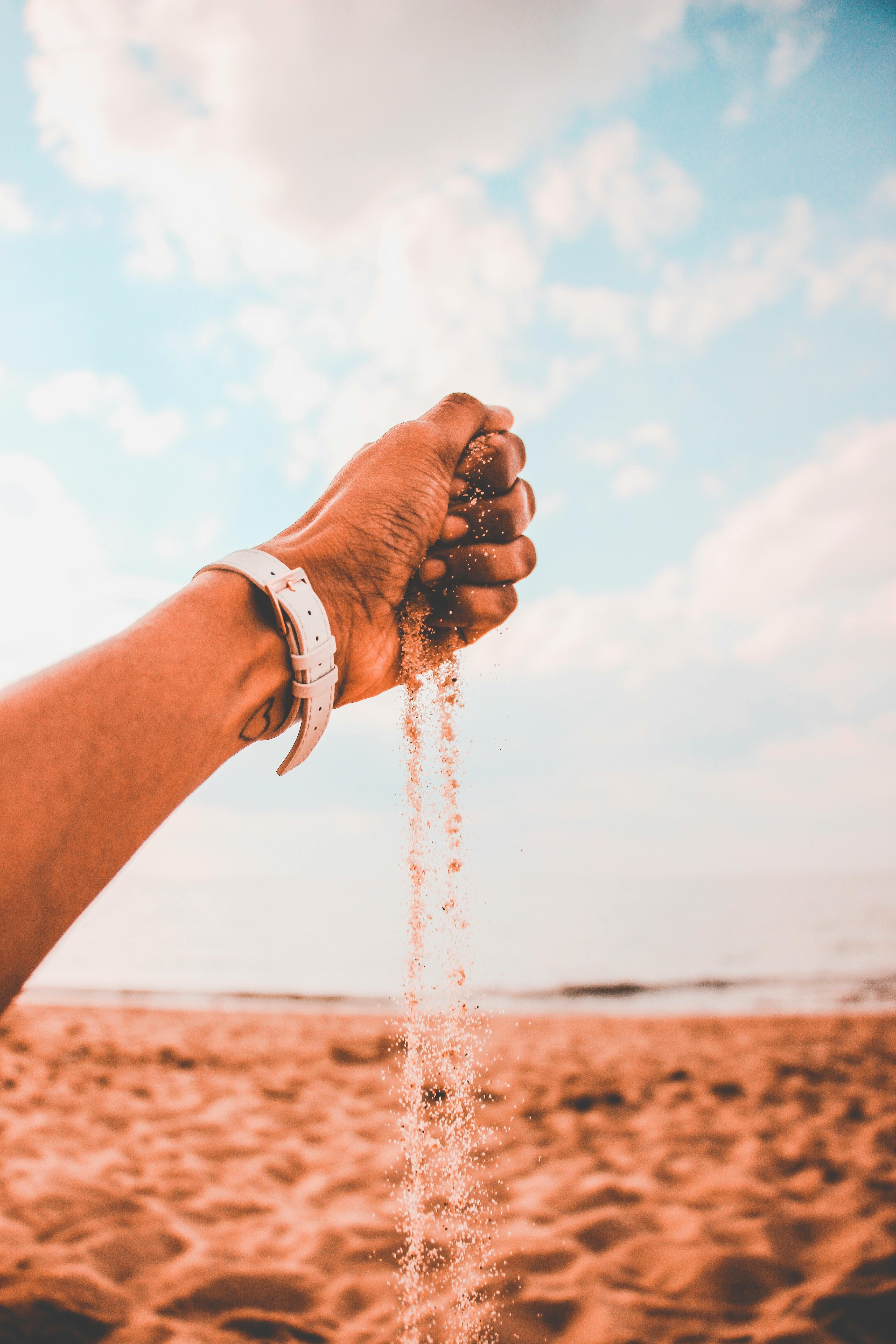 Person With Watch Grabbing Sand · Free Stock Photo