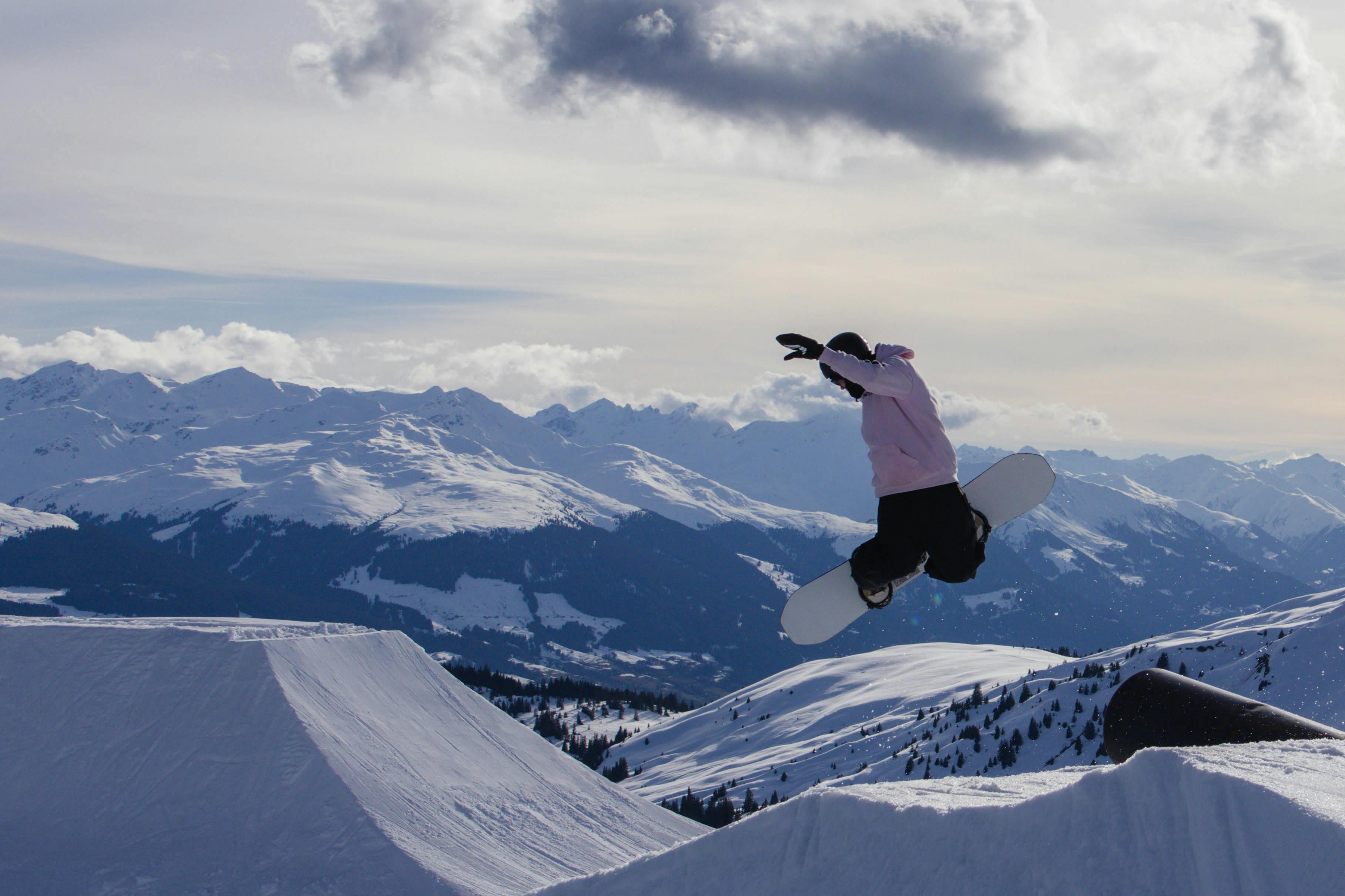 Thrilling Snowboarding Jump in Swiss Alps · Free Stock Photo