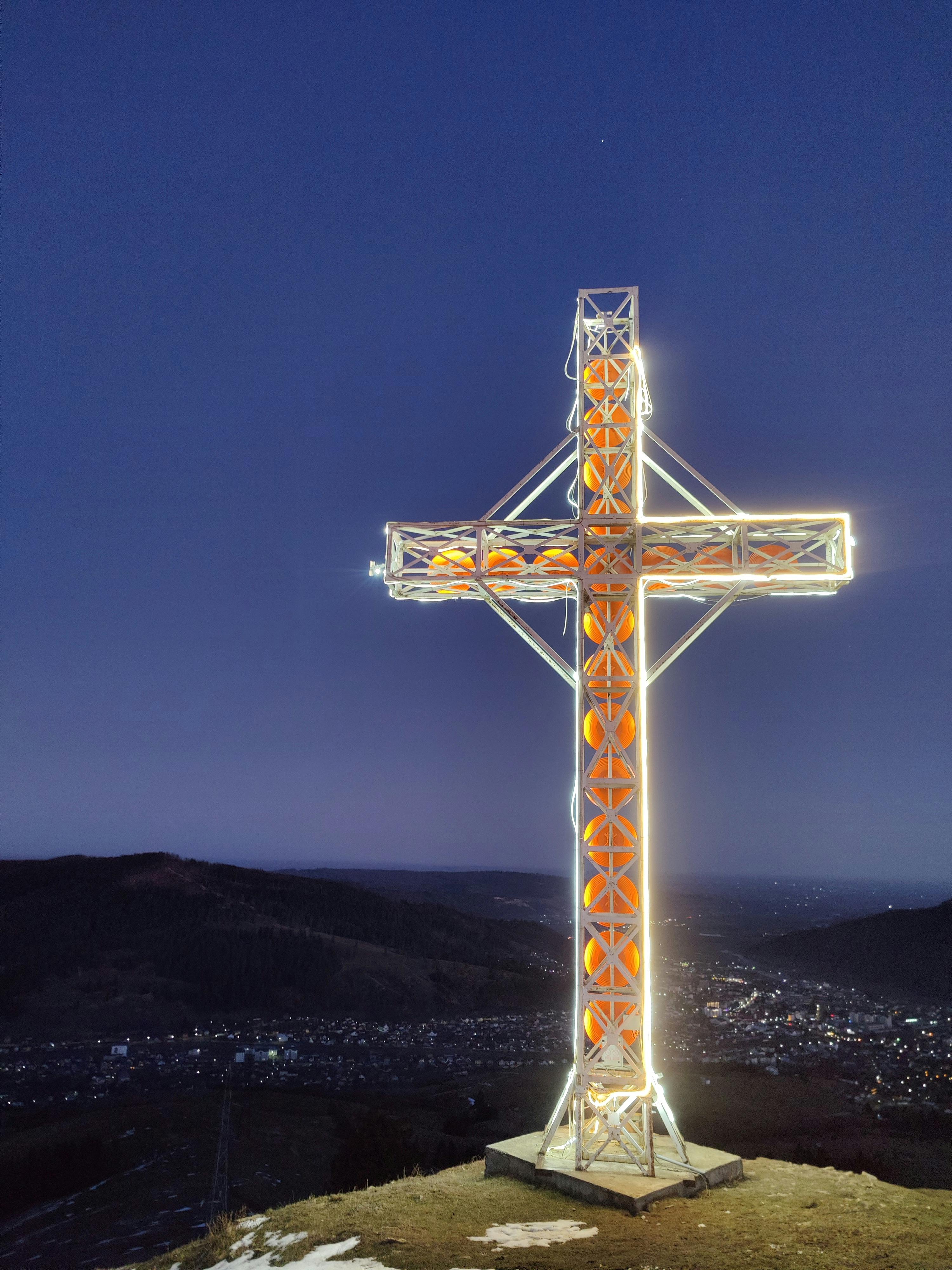 Illuminated Cross Overlooking a Cityscape at Night · Free Stock Photo