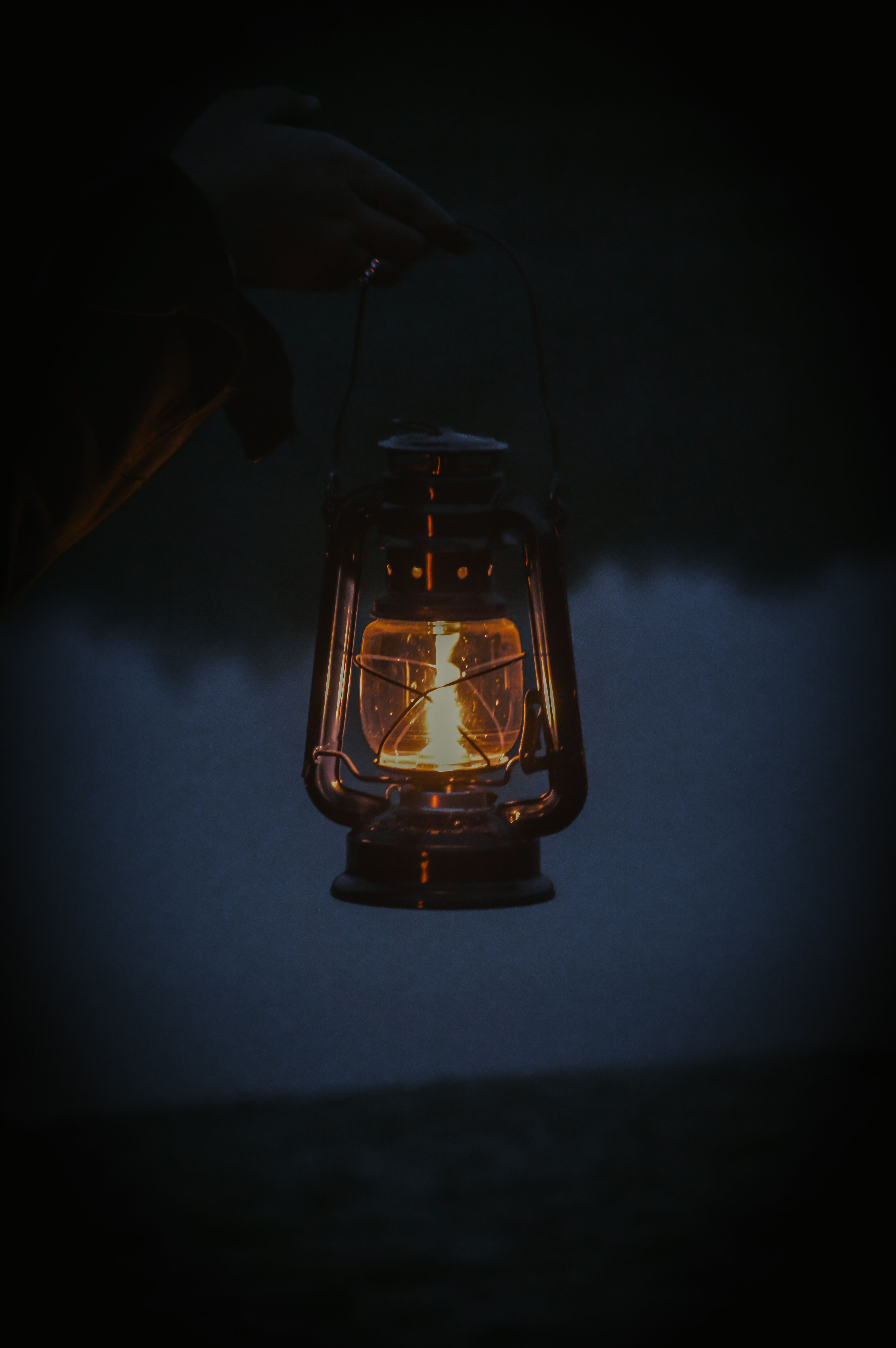 Hand Holding Lantern at Night Outdoors · Free Stock Photo