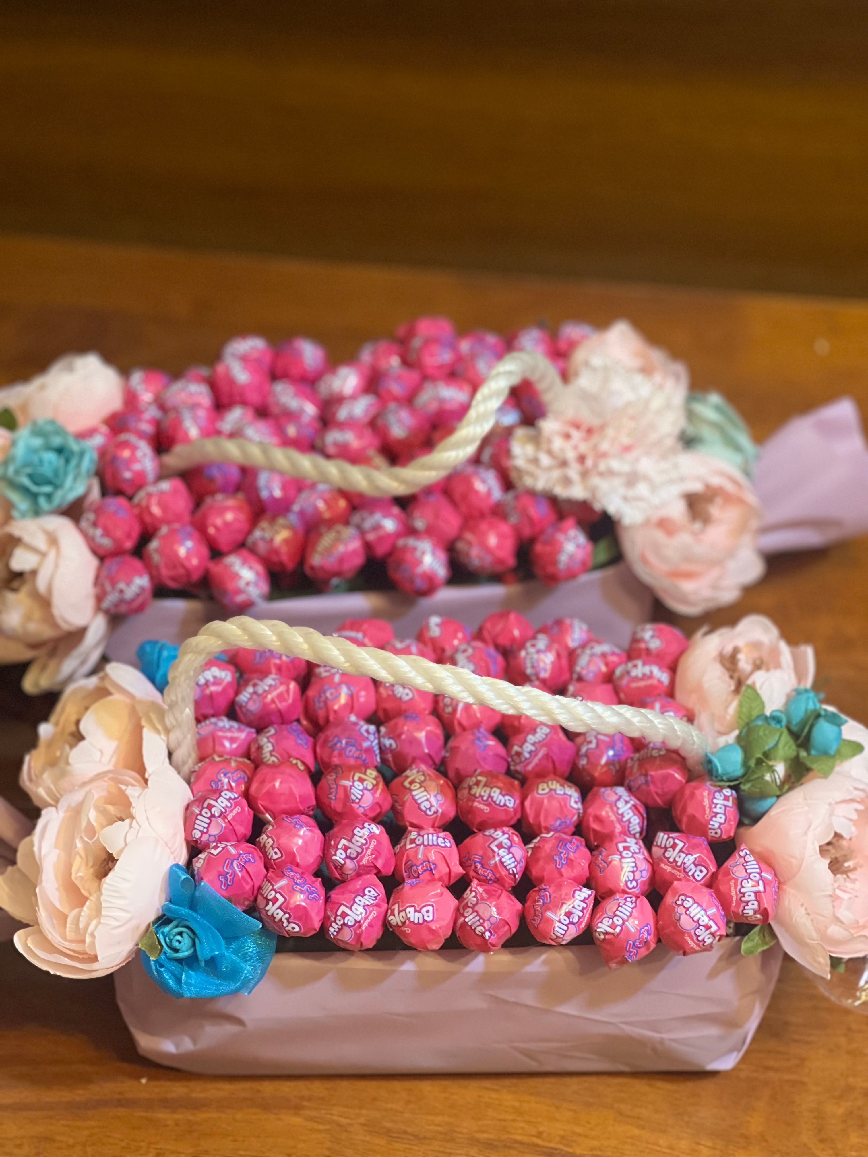 Pink Candy Flower Arrangement on Wooden Surface · Free Stock Photo
