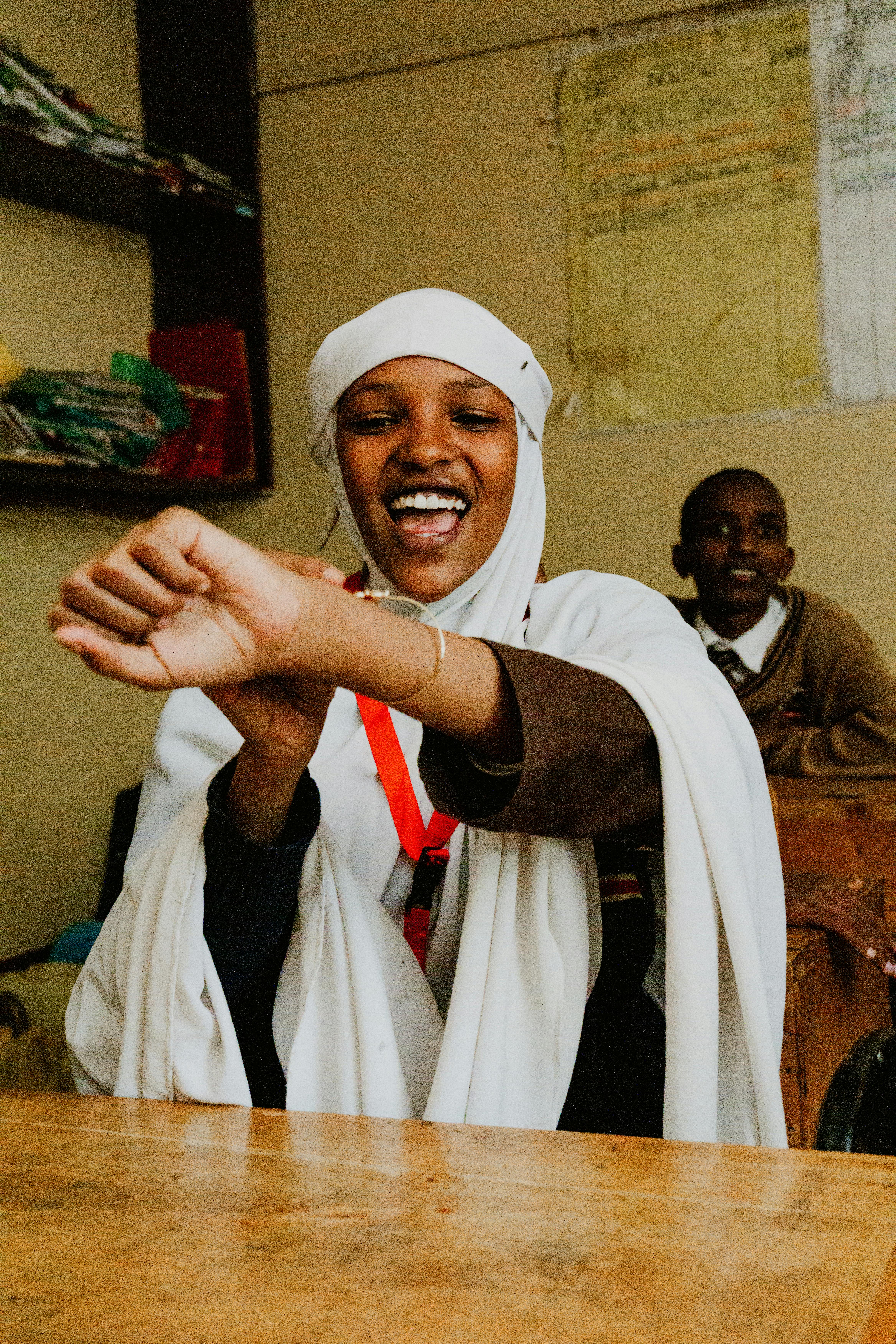 Smiling Student in Classroom Wearing Traditional Attire · Free Stock Photo
