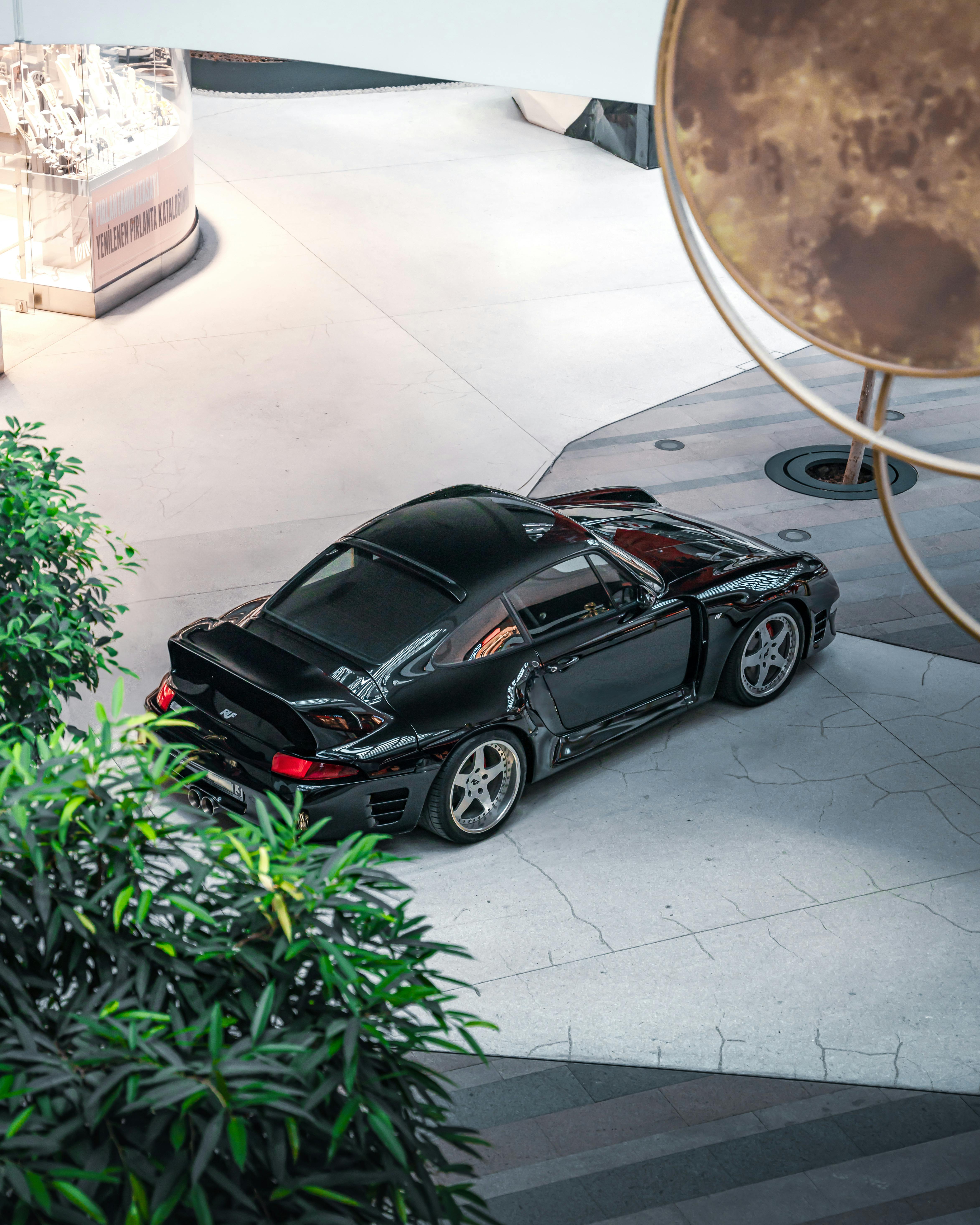 Luxury Black Sports Car Display in Modern Setting · Free Stock Photo