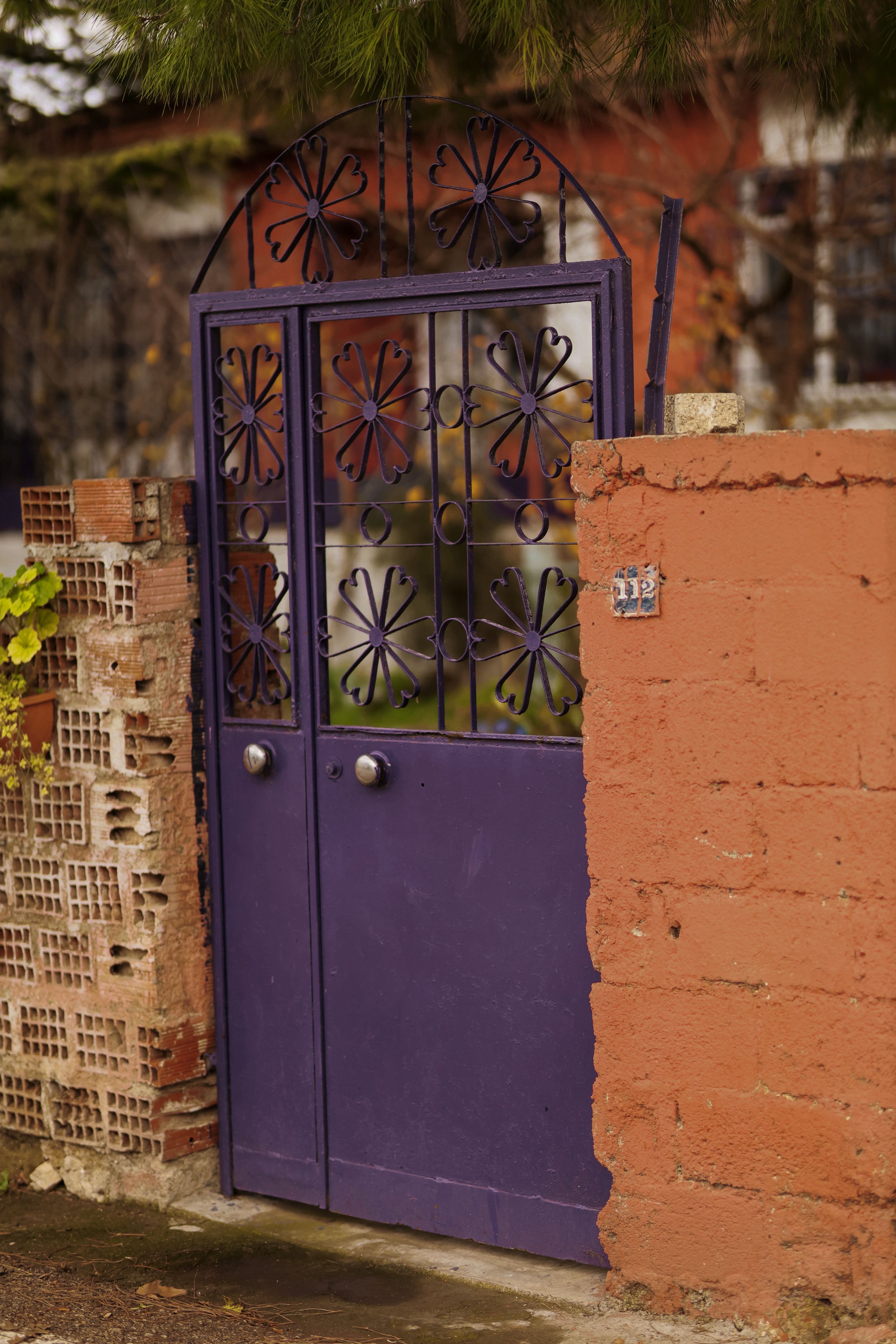 Charming Vintage Purple Iron Gate with Brick Wall · Free Stock Photo