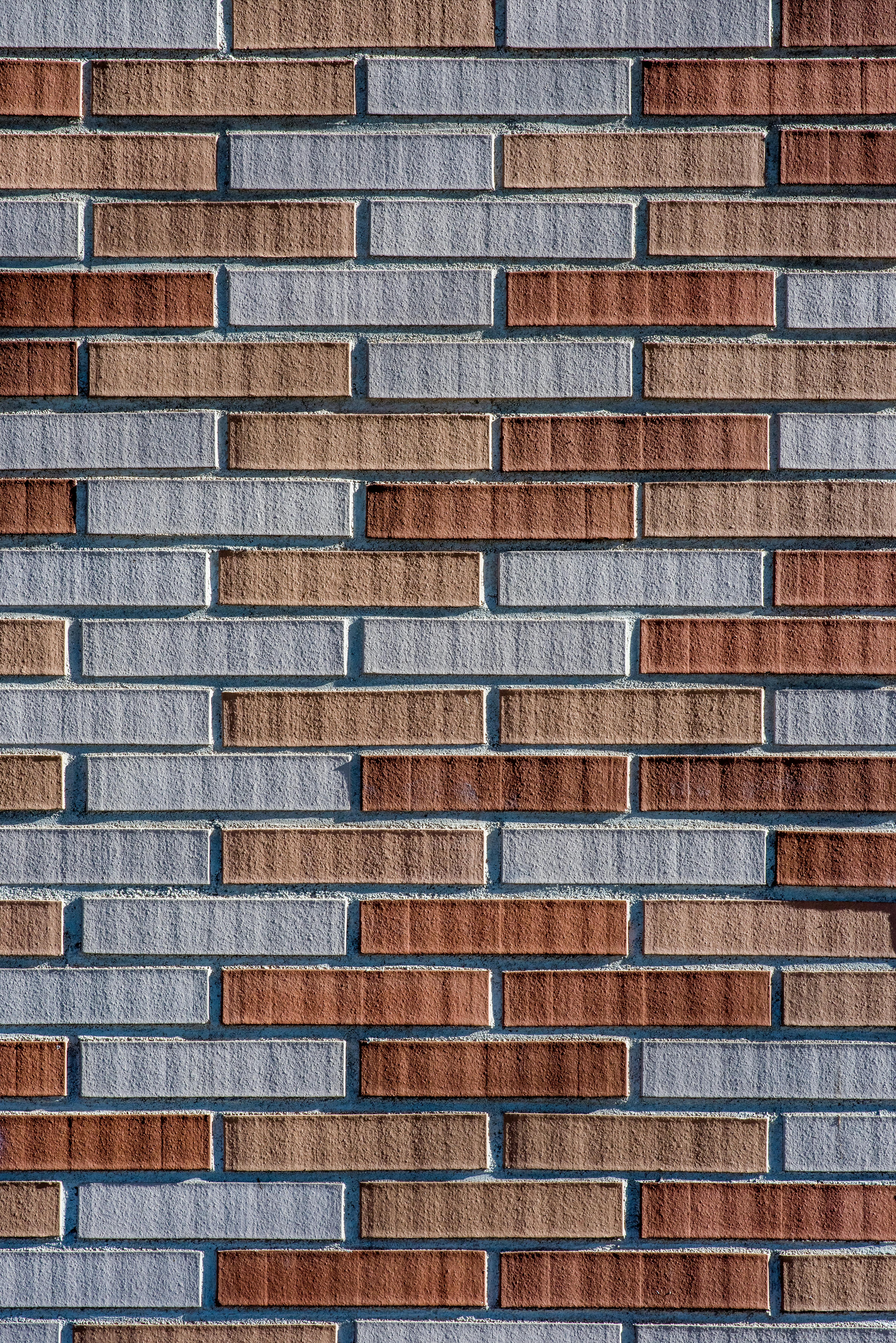 Patterned Brick Wall with Red and Gray Tones · Free Stock Photo