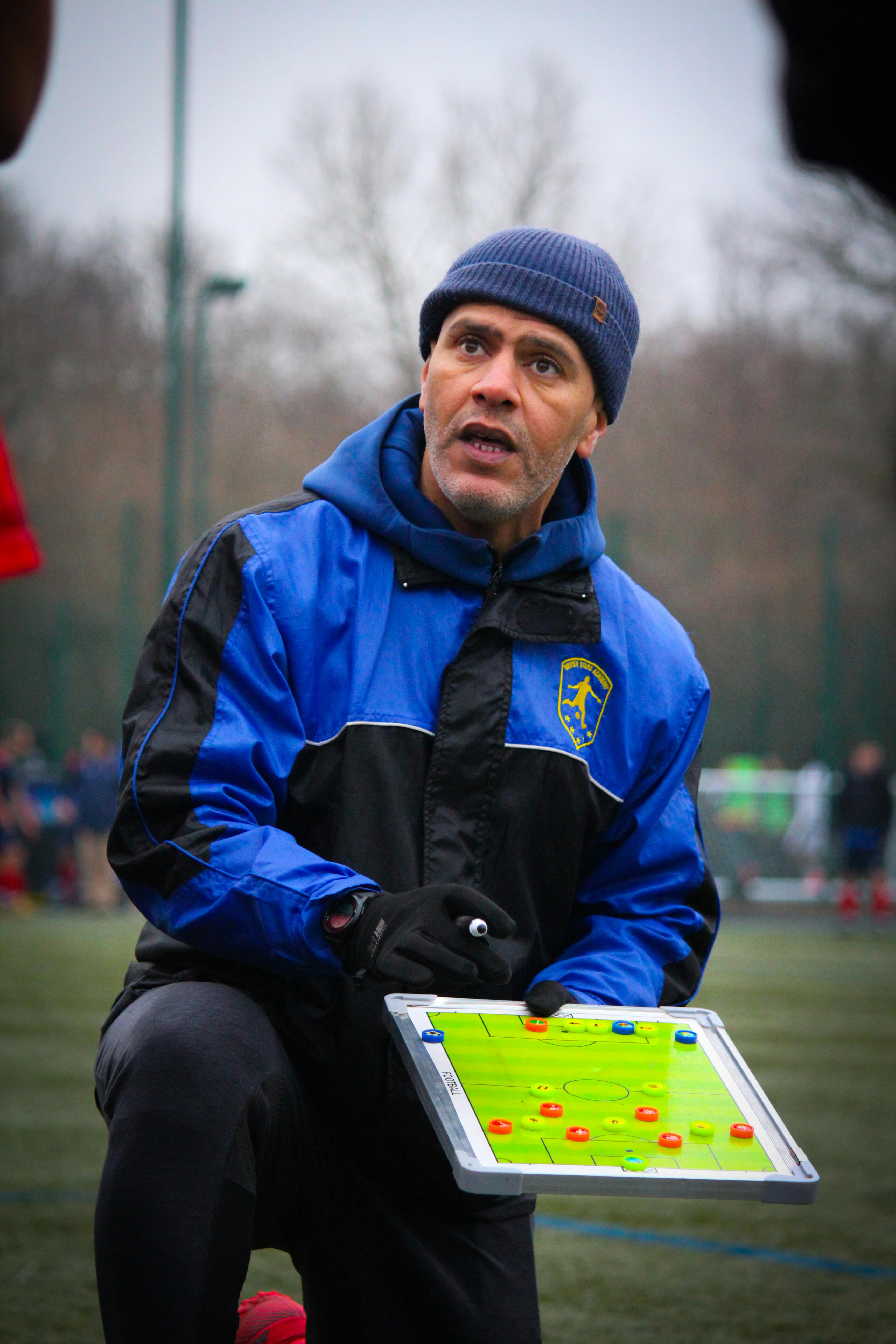 Soccer Coach Giving Tactical Instructions Outdoors · Free Stock Photo