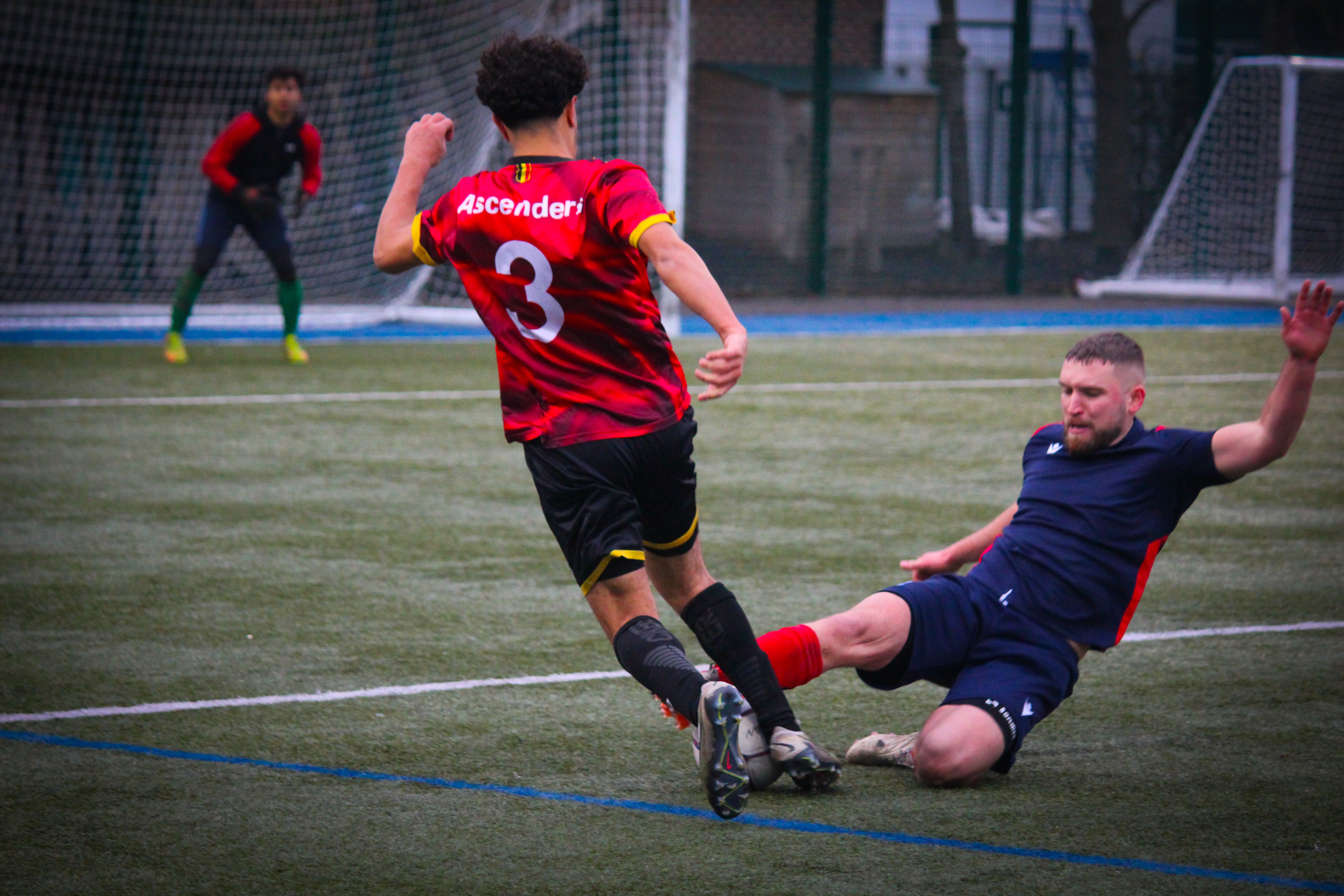 Dynamic Soccer Tackle on Outdoor Field · Free Stock Photo
