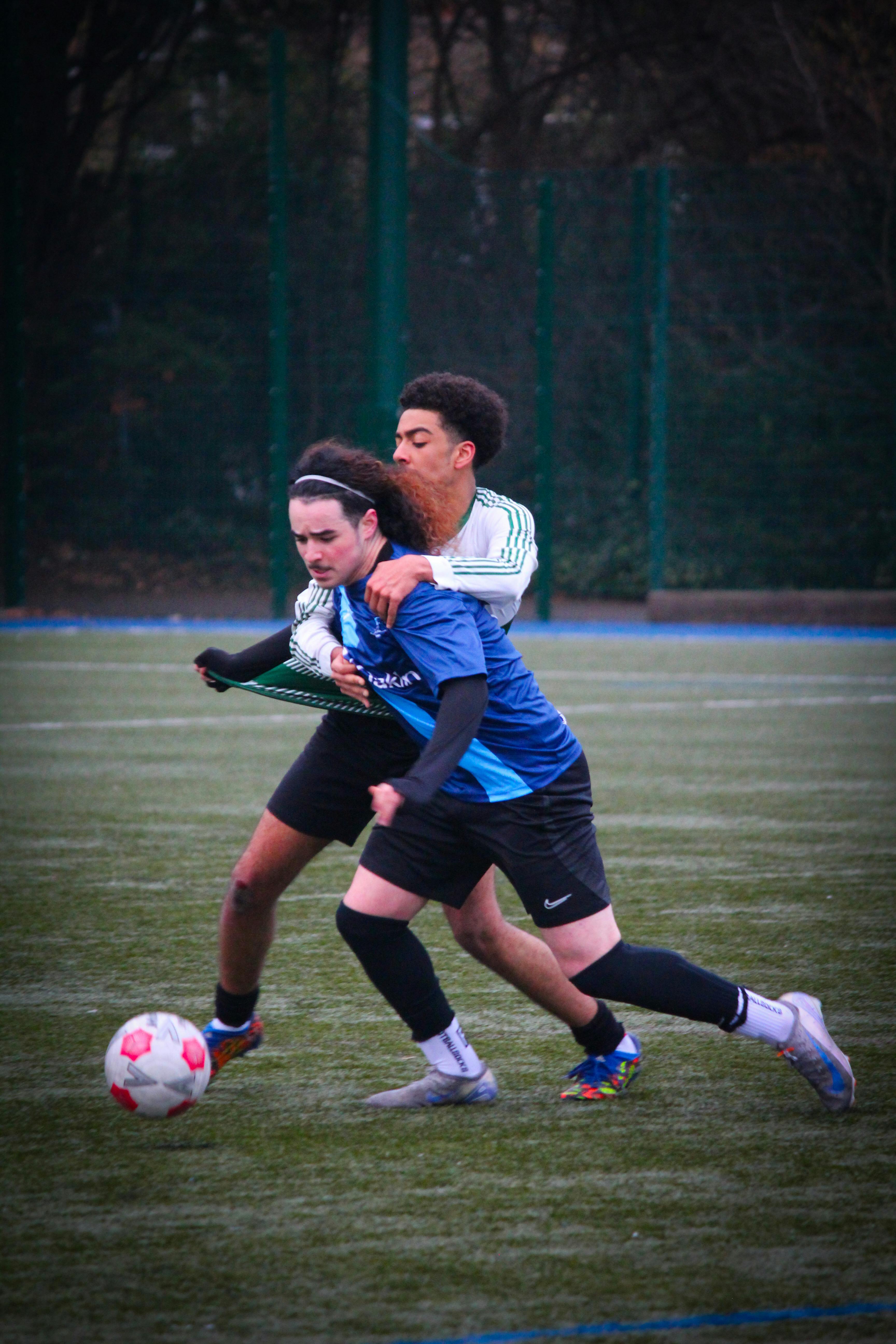Intense Soccer Match in Action on Green Field · Free Stock Photo