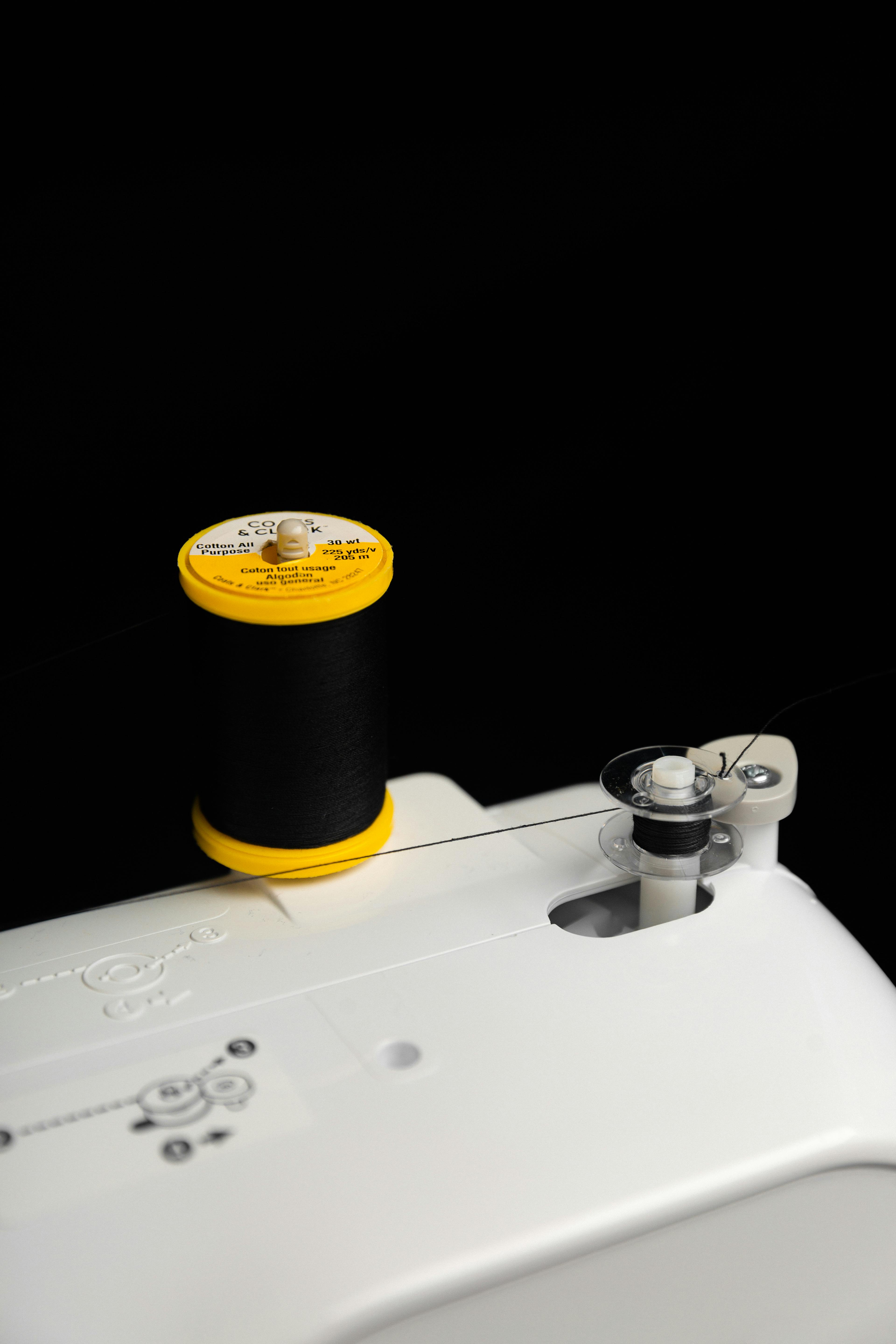 Close-Up of Thread and Sewing Machine Bobbin · Free Stock Photo