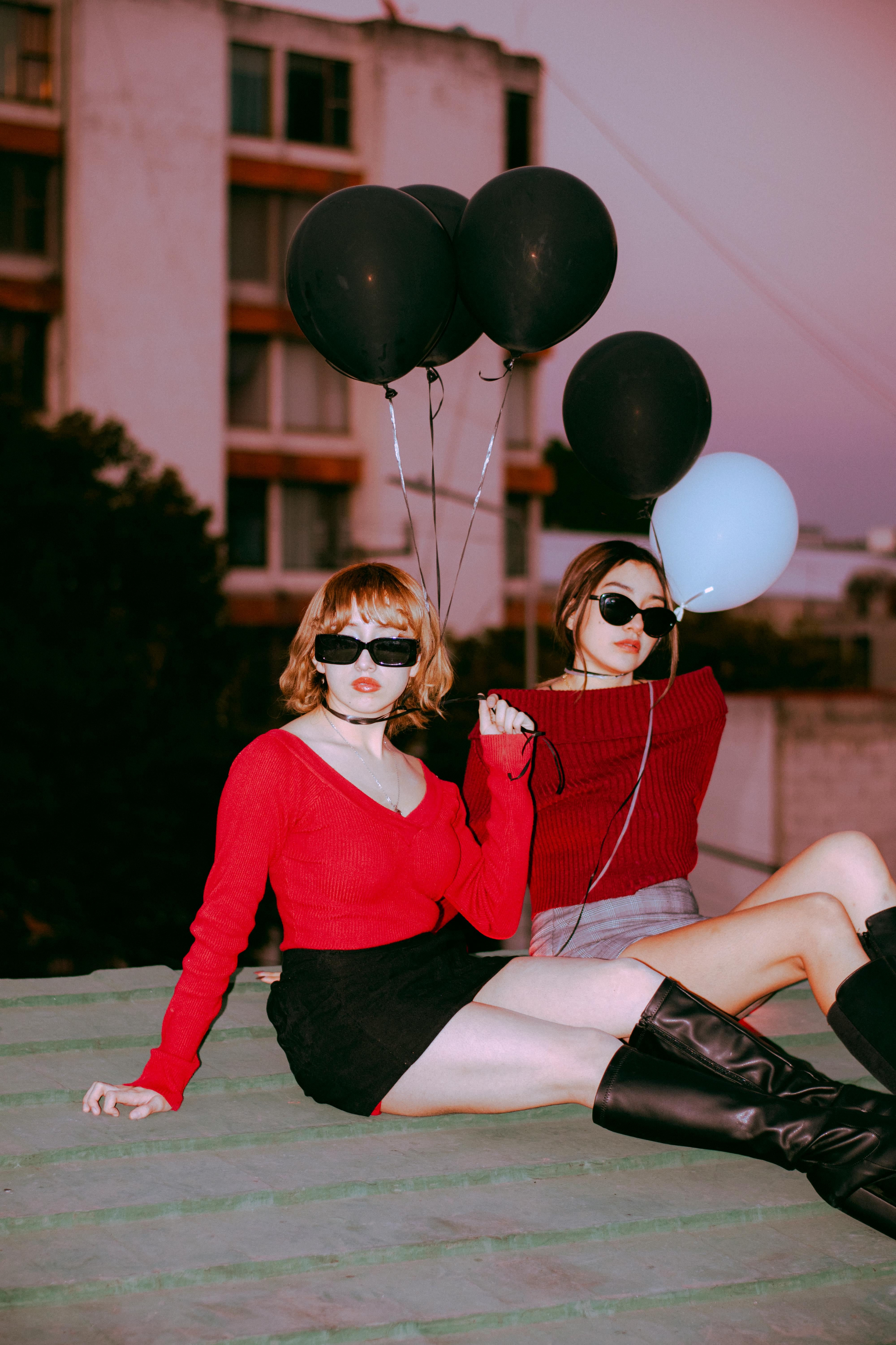 Stylish Women with Balloons on Rooftop · Free Stock Photo