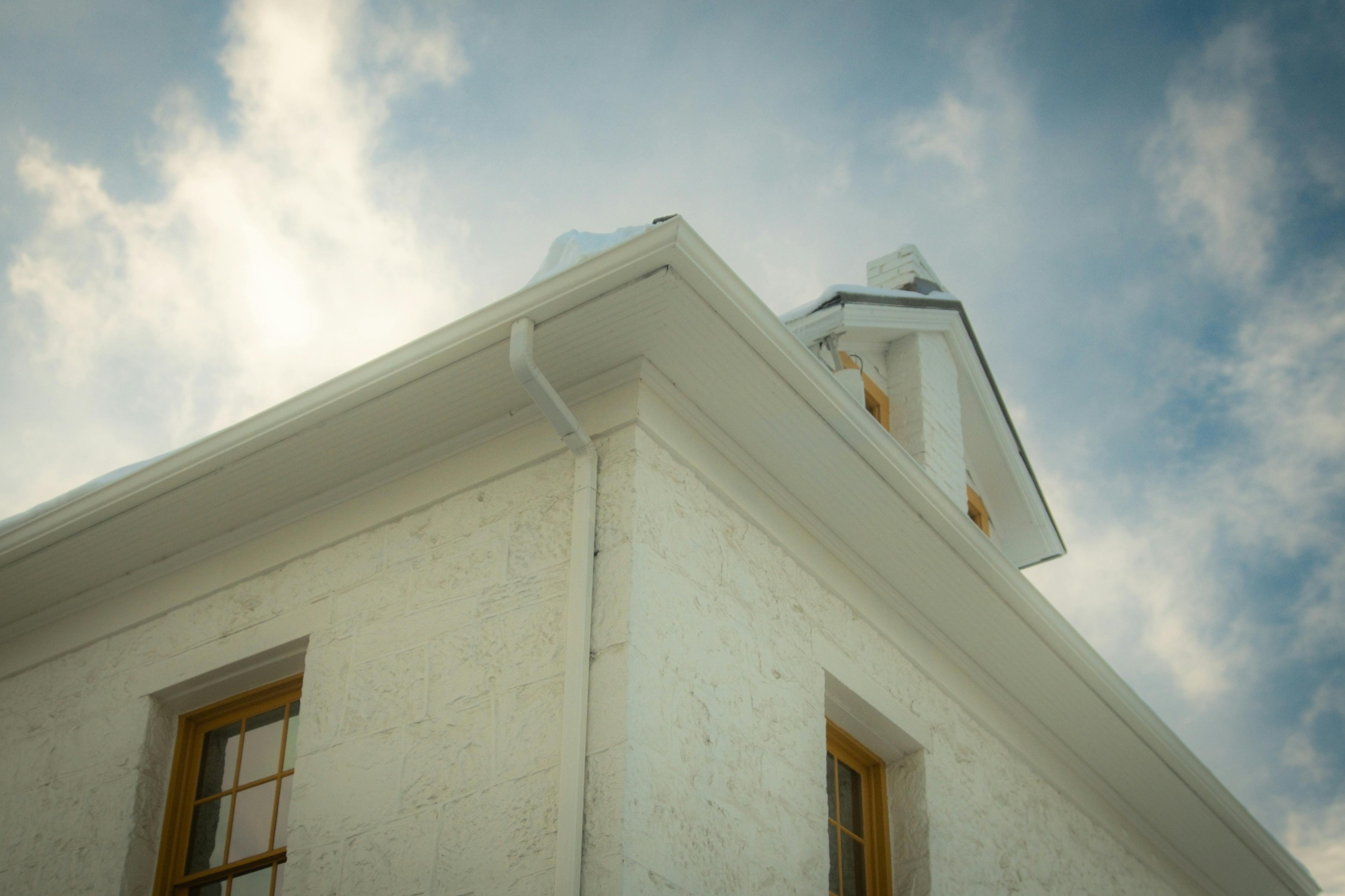 Elegant Vintage House Gable Under Clouded Sky · Free Stock Photo