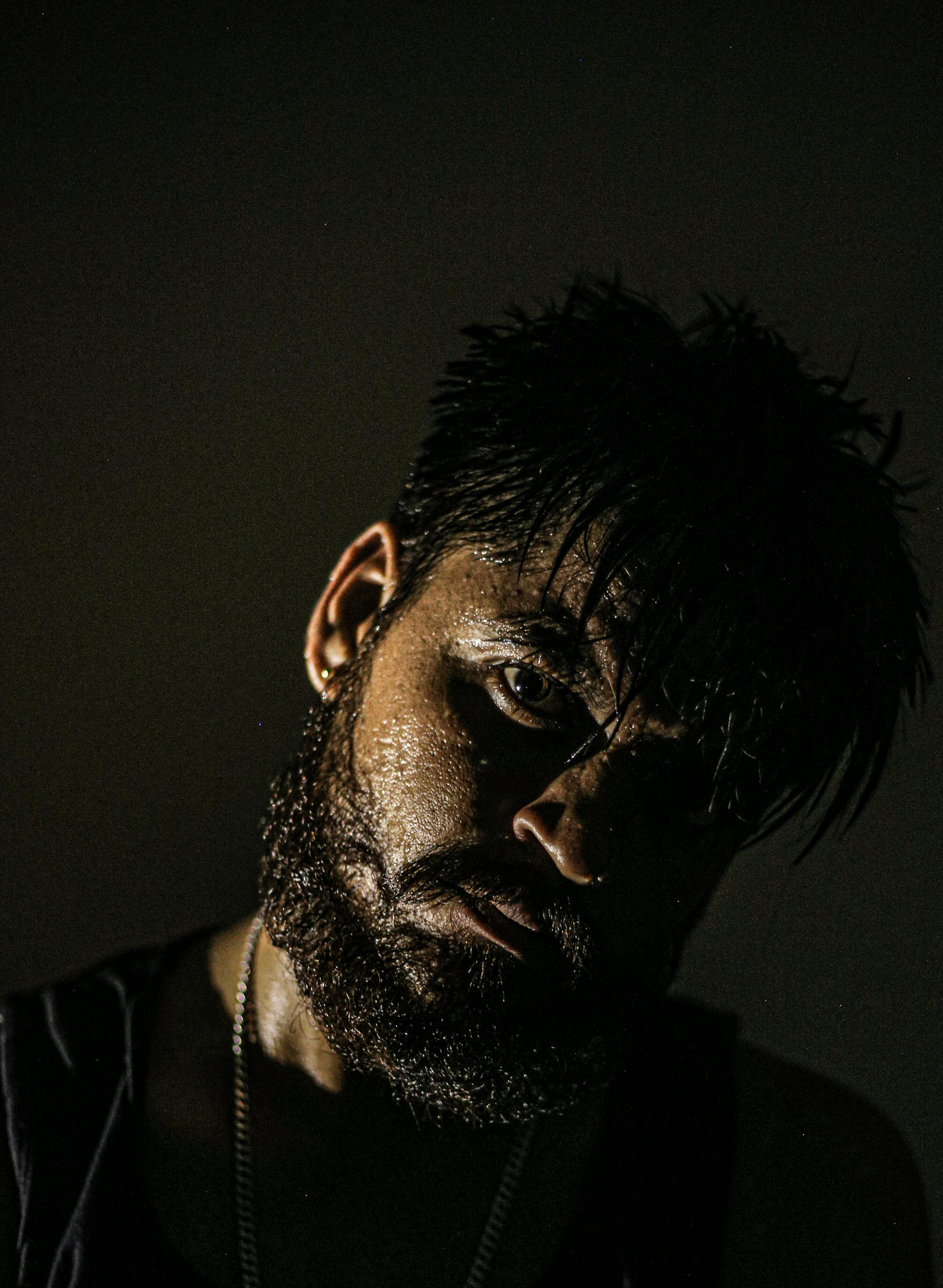 Dramatic Low-Light Portrait of a Man in Studio · Free Stock Photo