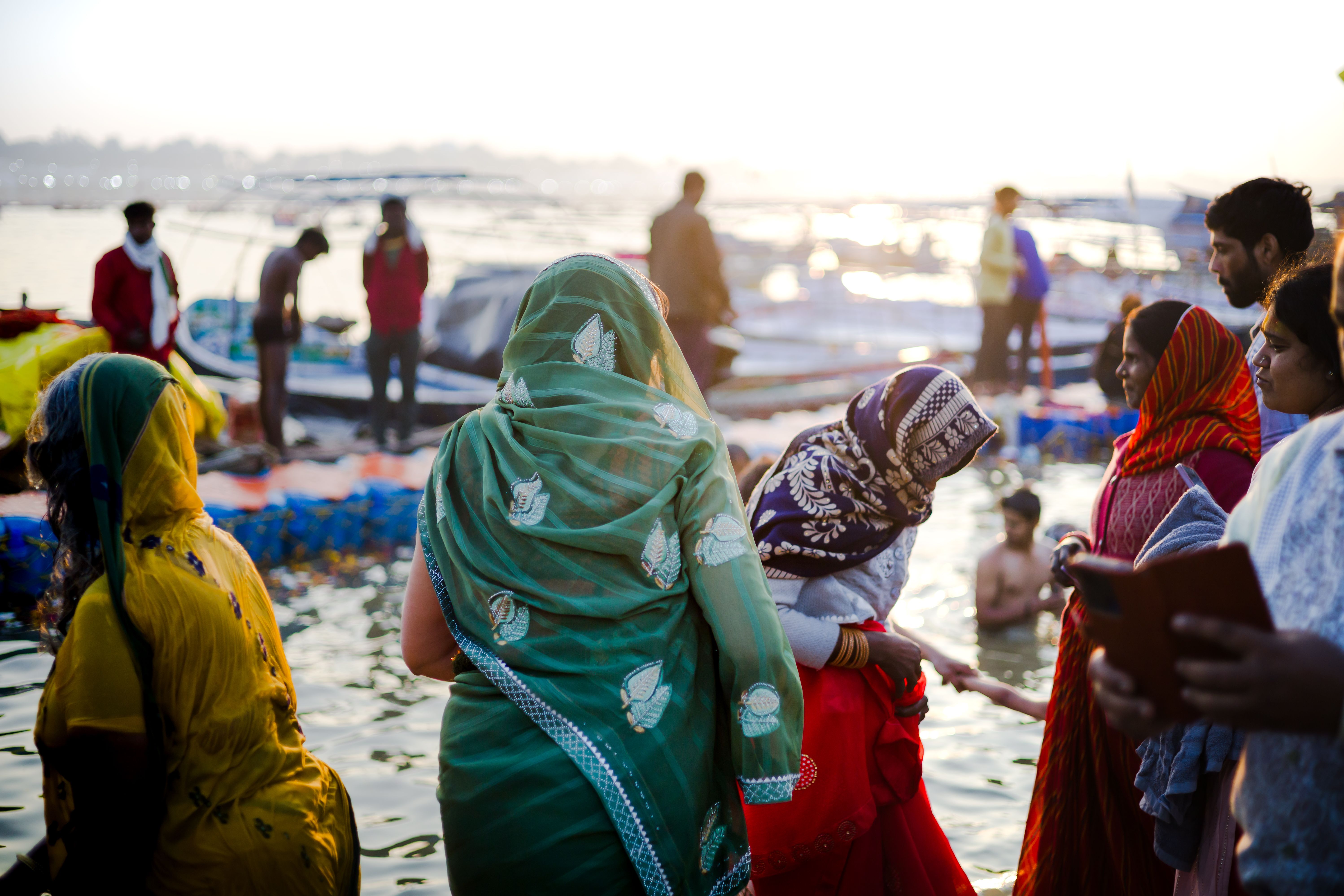 Cultural Gathering at River with Colorful Attire · Free Stock Photo