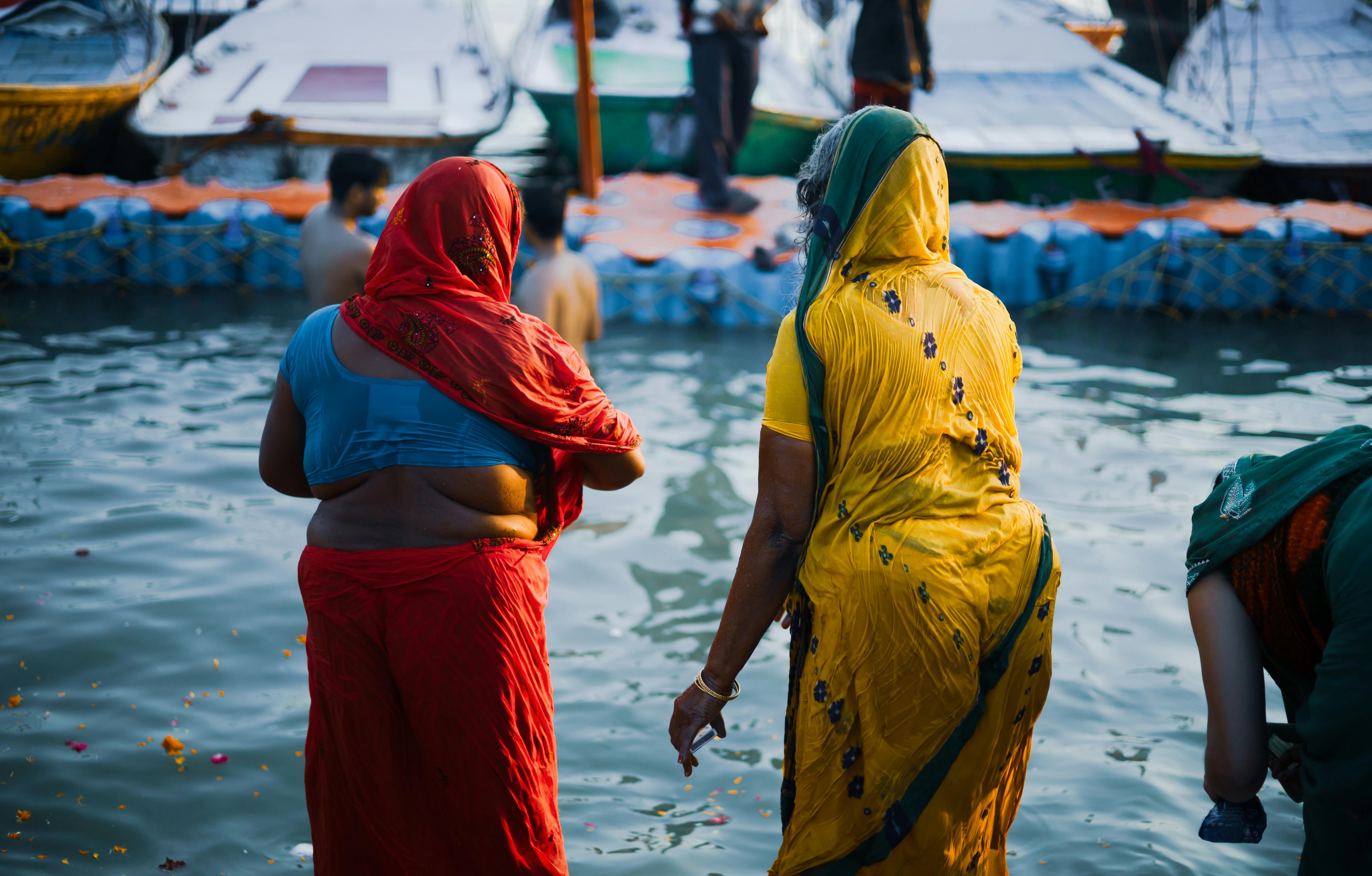 Cultural Ritual at a Riverbank with Women in Sarees · Free Stock Photo