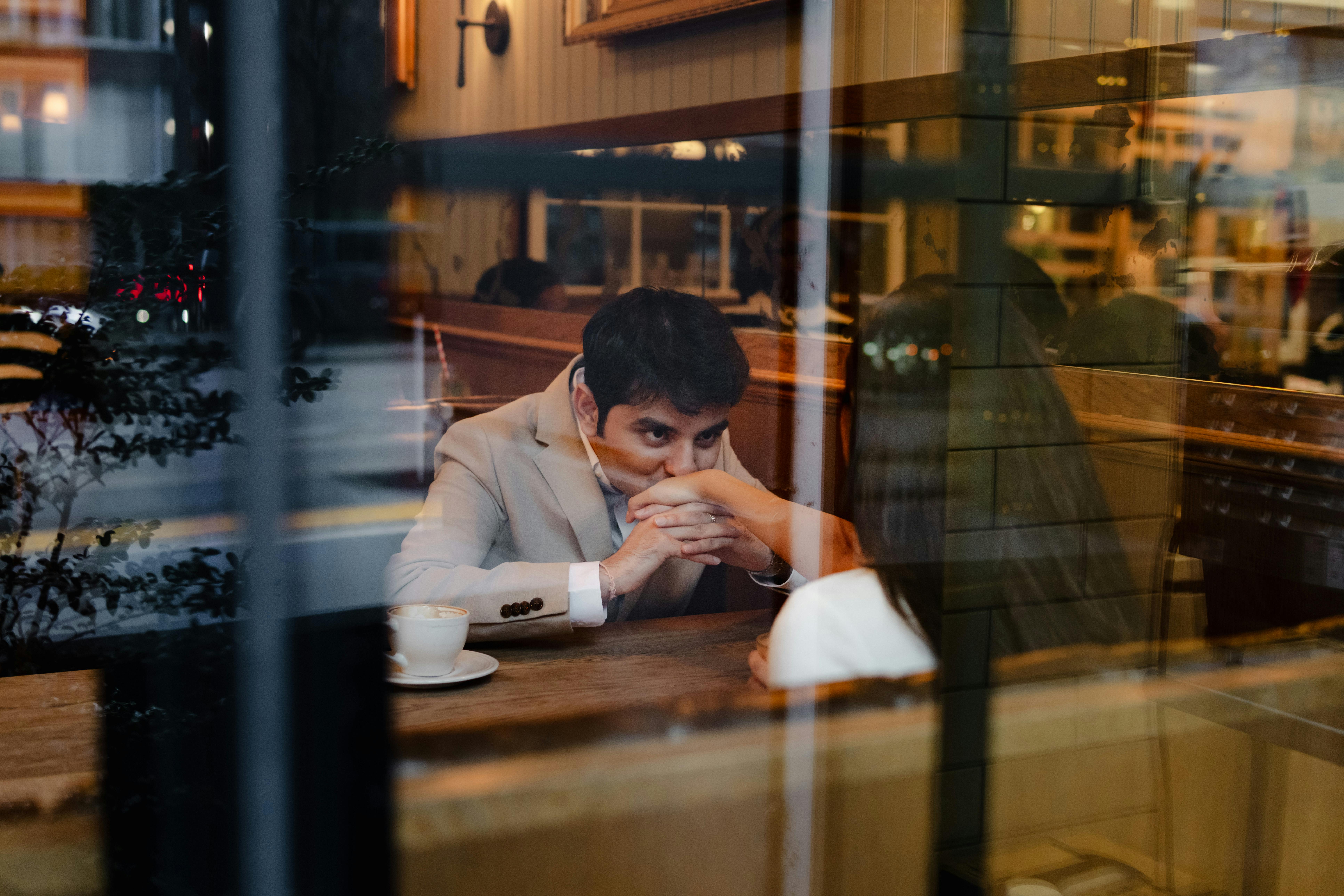 Romantic Couple Sharing Coffee in a Cozy Cafe · Free Stock Photo