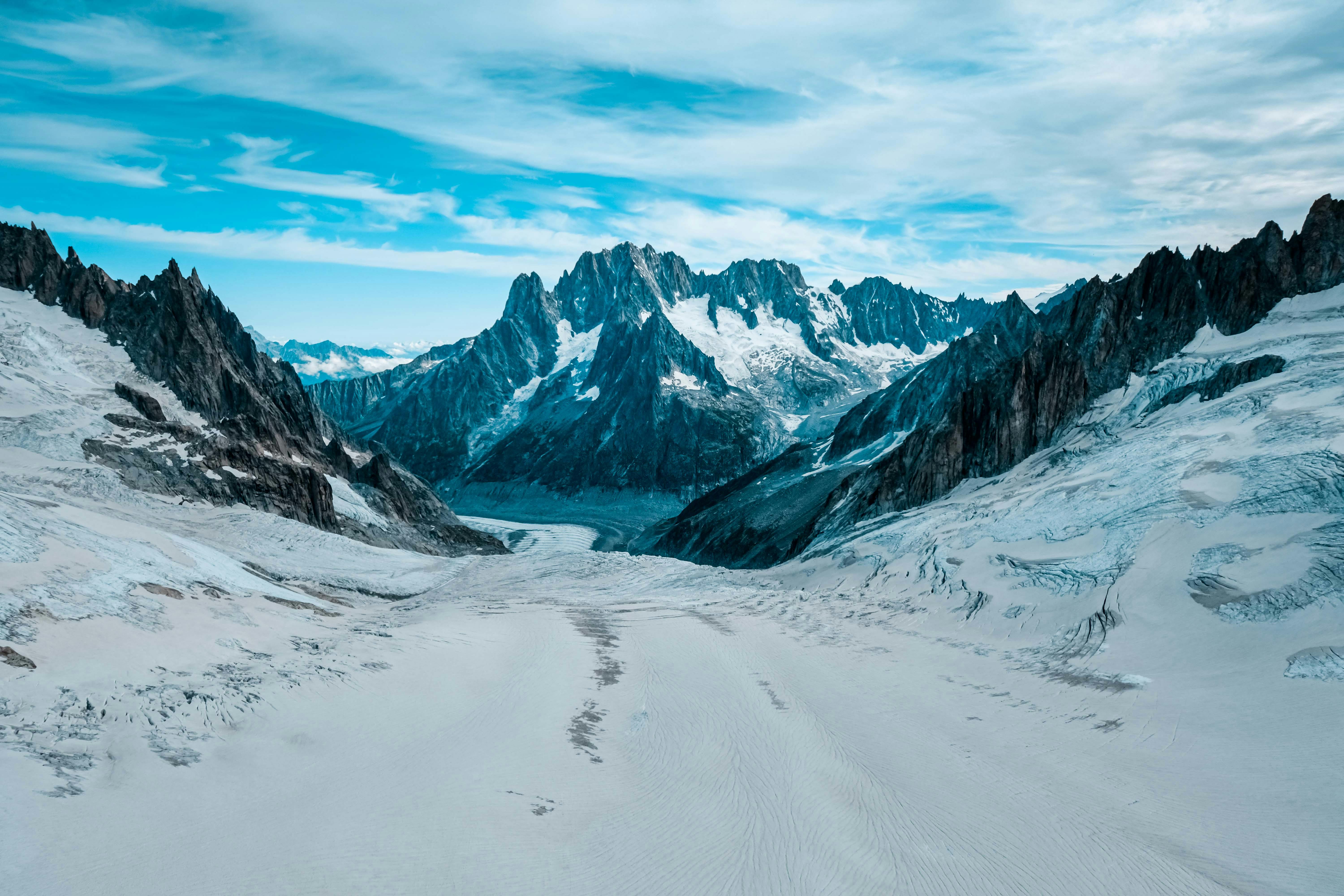 Snow-Covered Pathway Across Mountains · Free Stock Photo