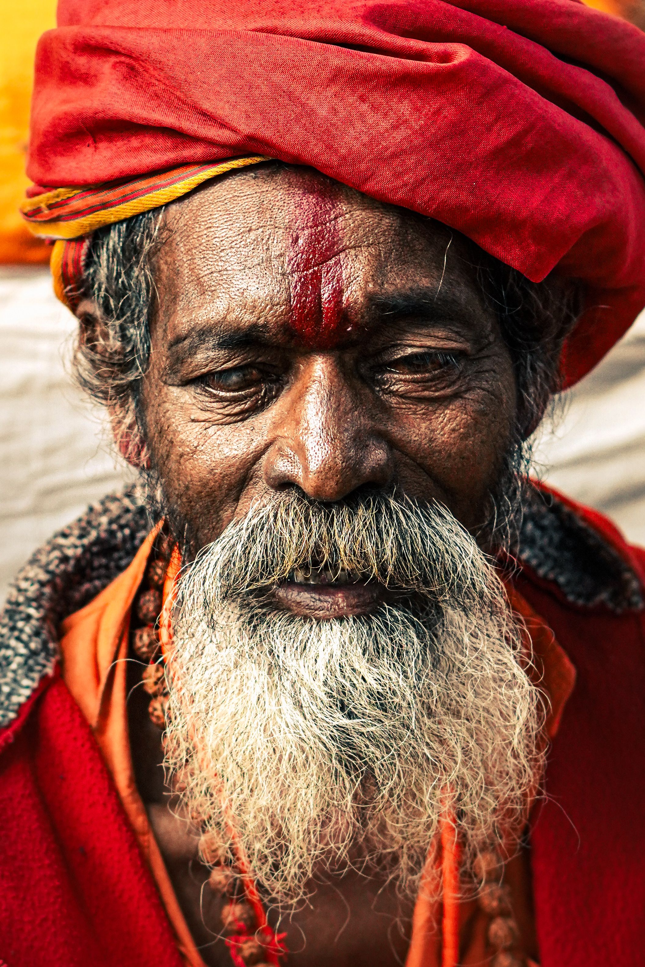 Portrait of a Holy Man in Vibrant Red Attire · Free Stock Photo