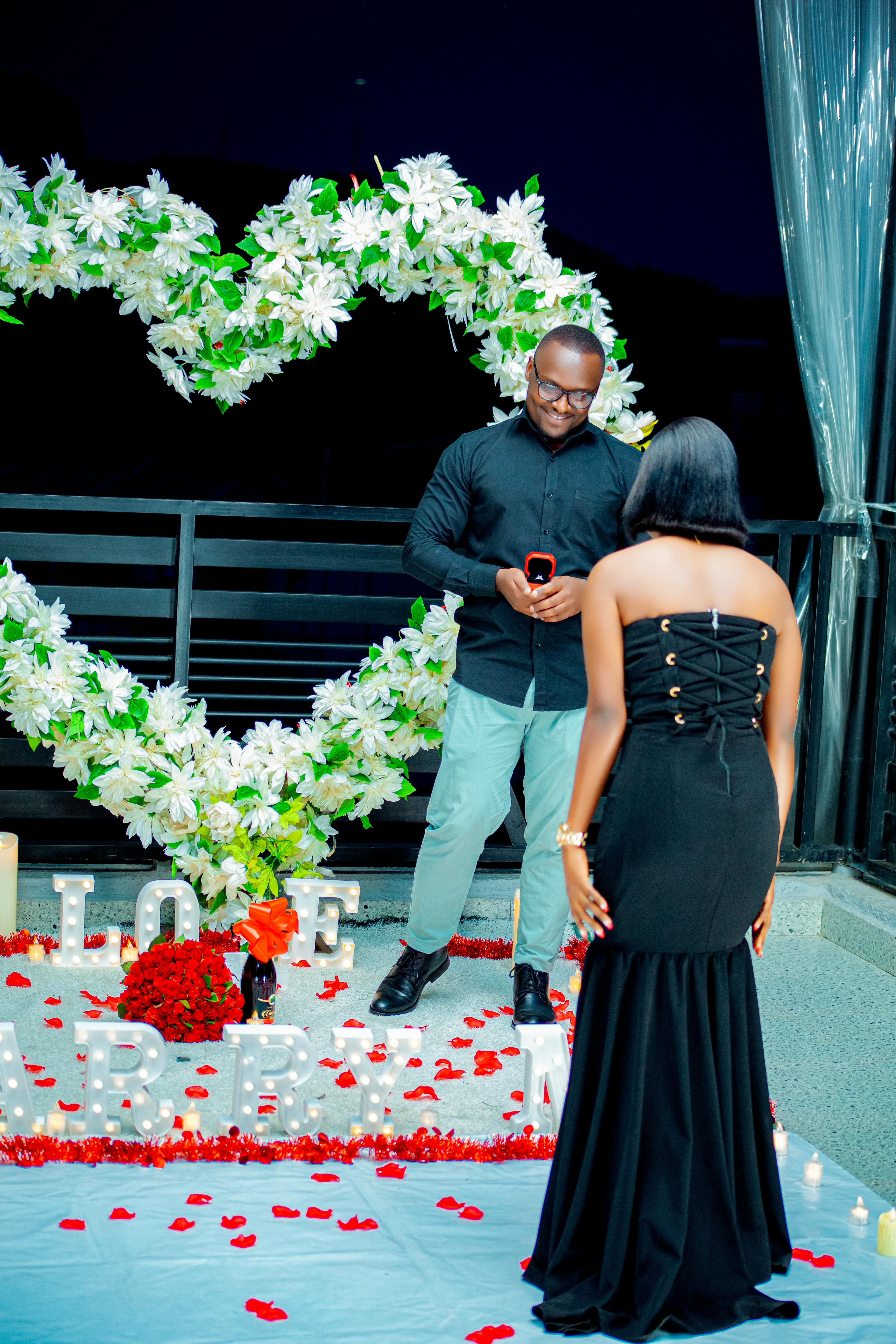 Romantic Proposal with Floral Heart Backdrop · Free Stock Photo