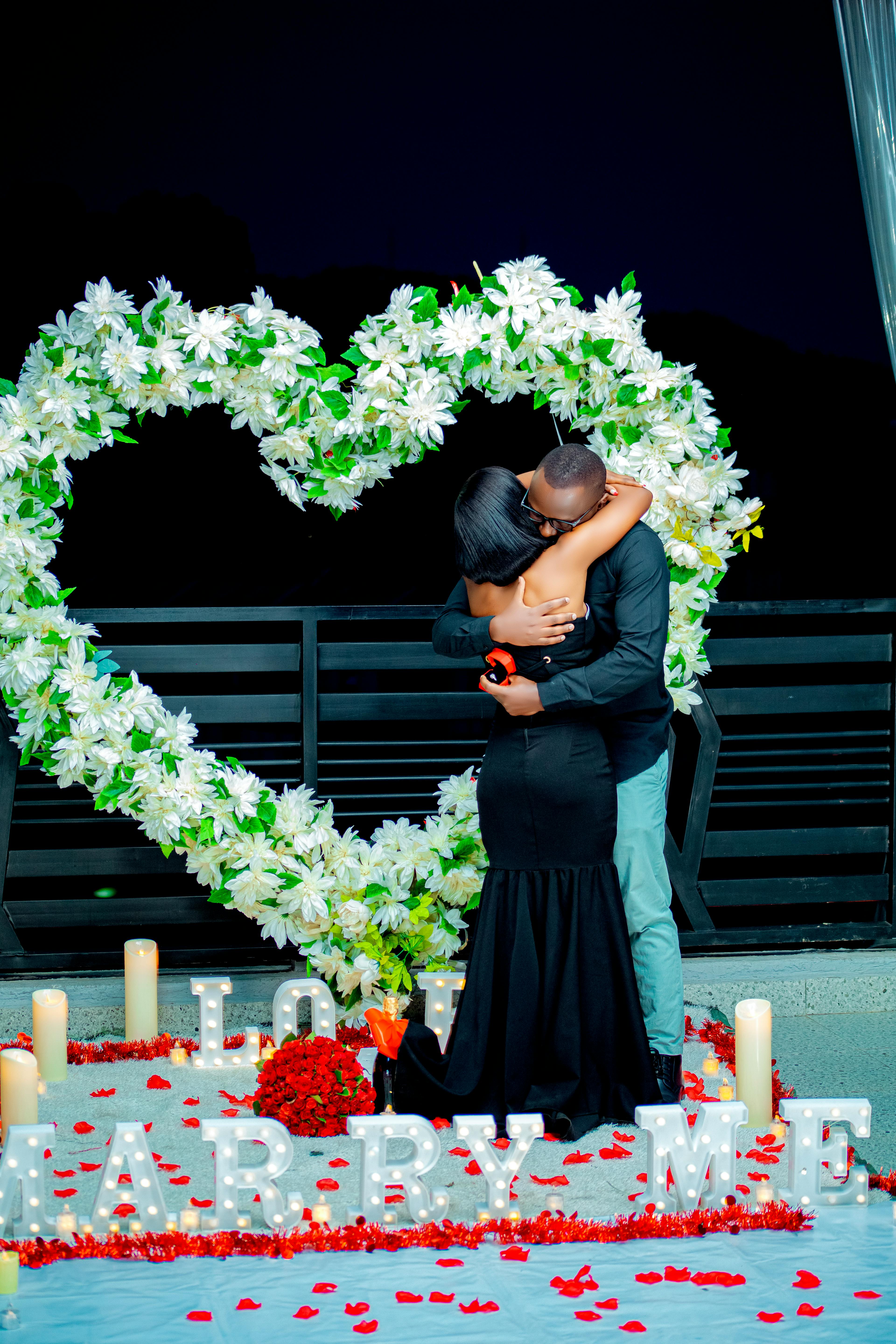 Romantic Proposal with Floral Heart Backdrop · Free Stock Photo