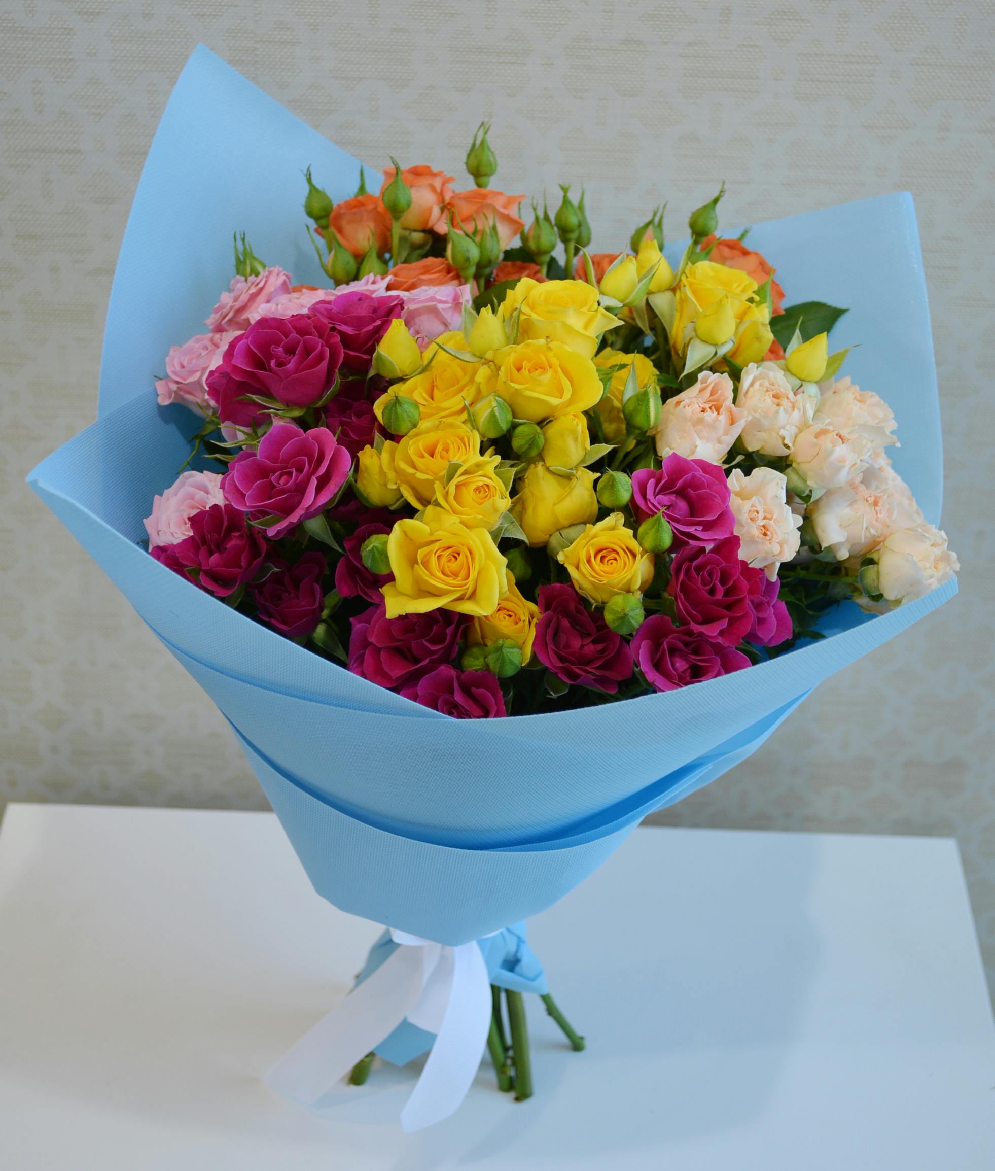 Vibrant Multicolored Flower Bouquet in Blue Wrap · Free Stock Photo