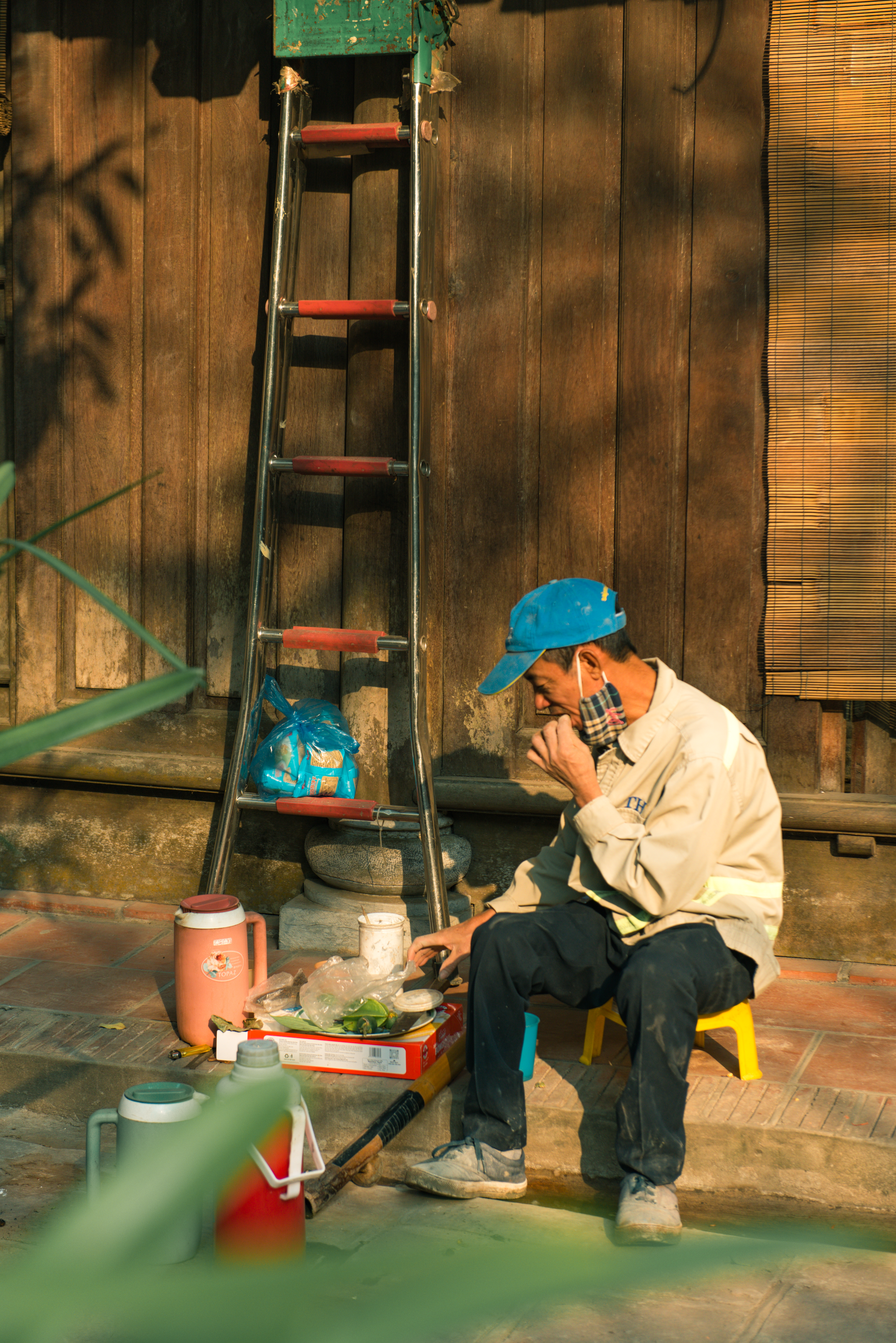 Vietnamese Street Vendor on a Phone Call · Free Stock Photo