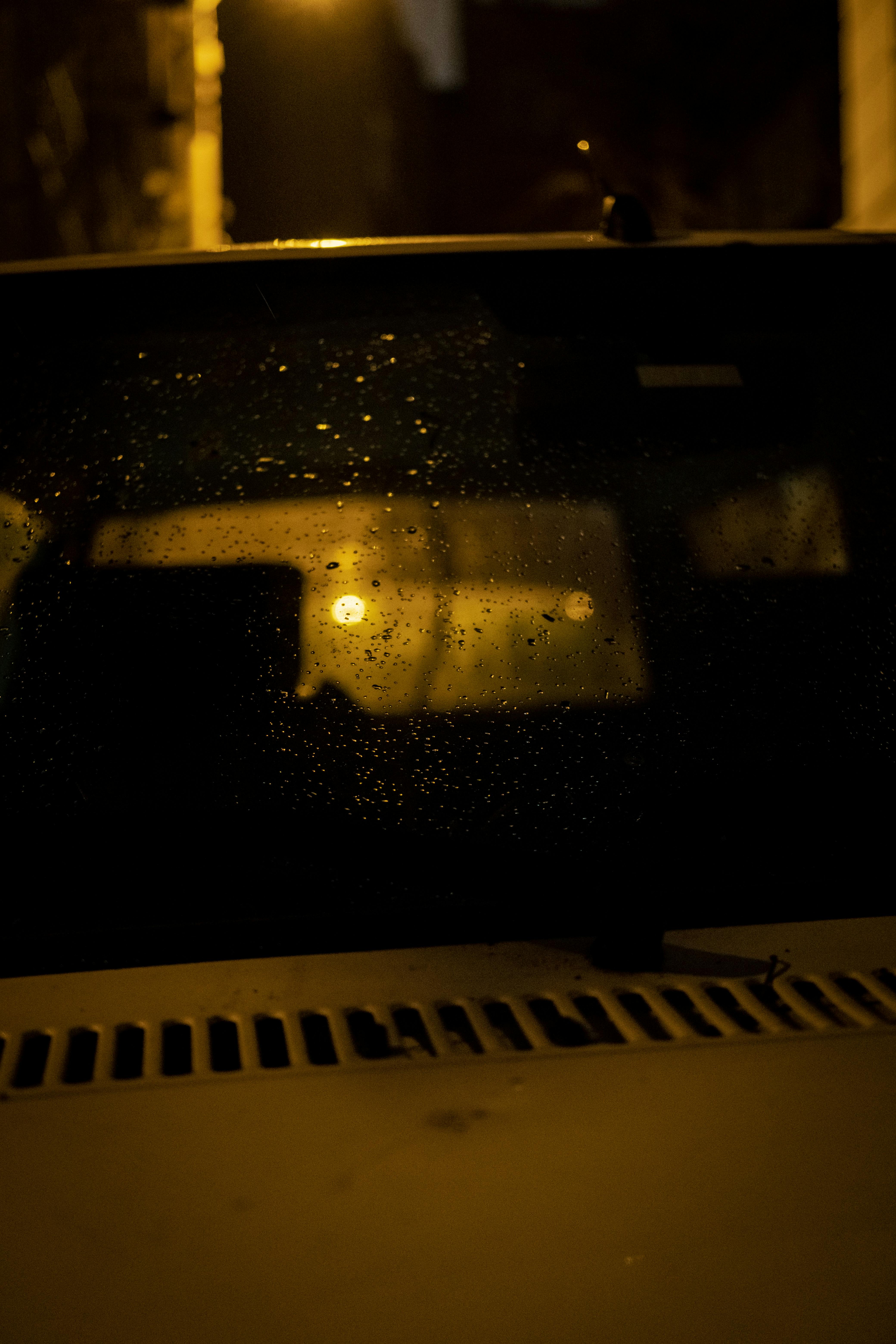 Moody Nighttime Rainfall on Car Windshield View · Free Stock Photo