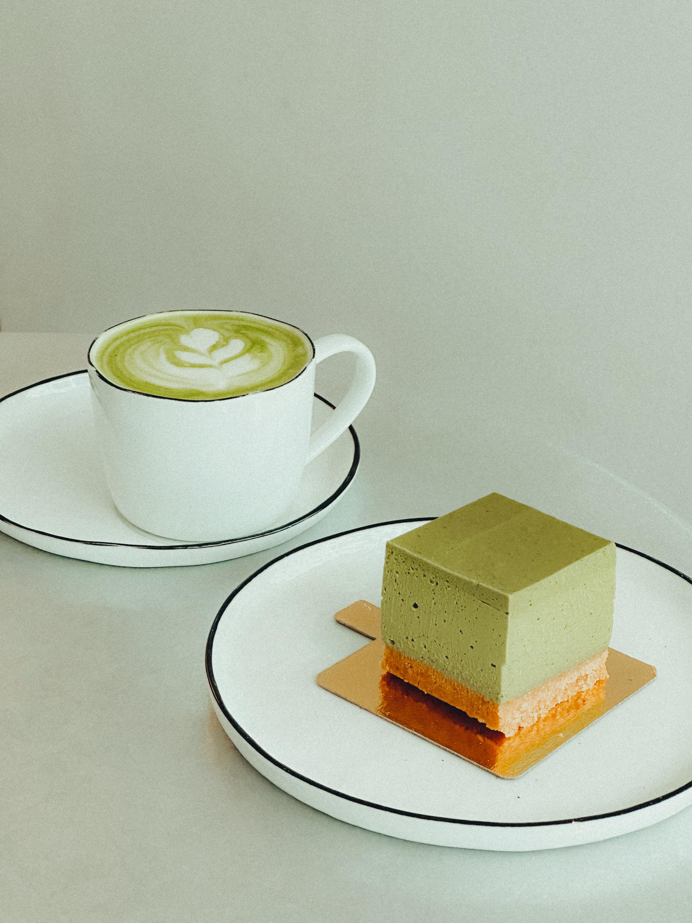 Minimalist Matcha Latte and Cake on White Plates · Free Stock Photo
