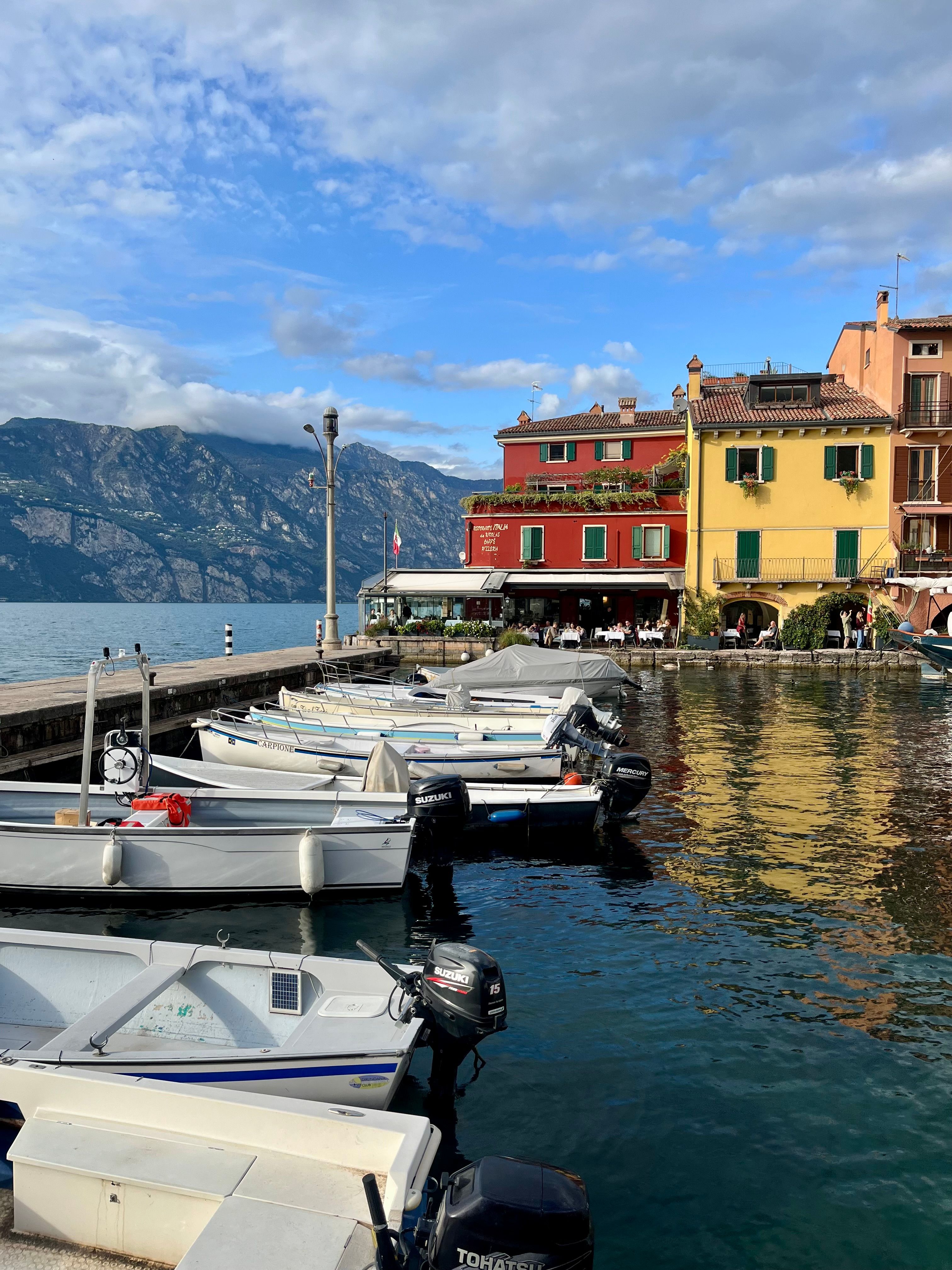 Colorful Italian Lakefront with Boats and Mountains · Free Stock Photo