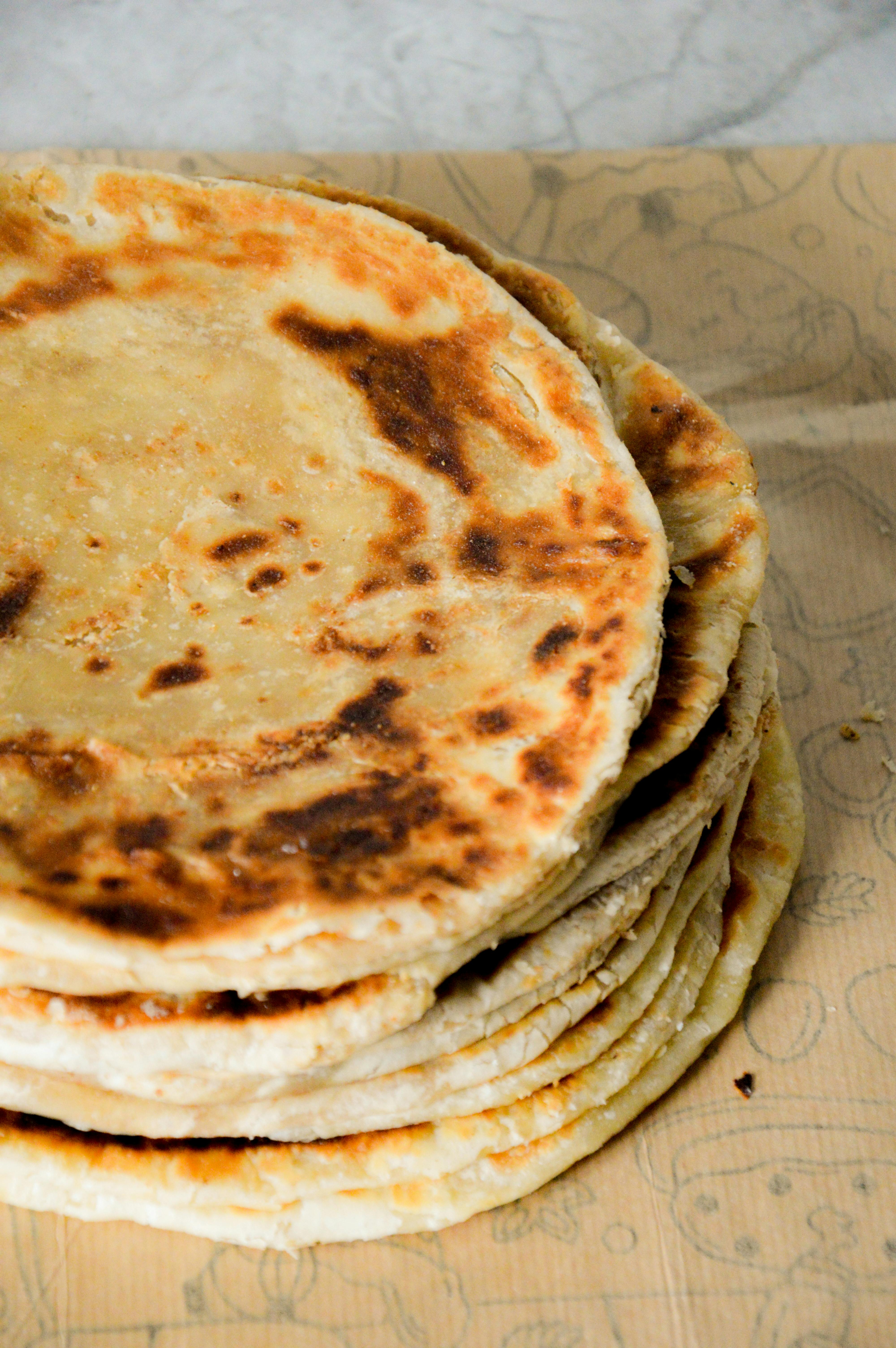 Rustic Flatbread Stack on Brown Paper · Free Stock Photo