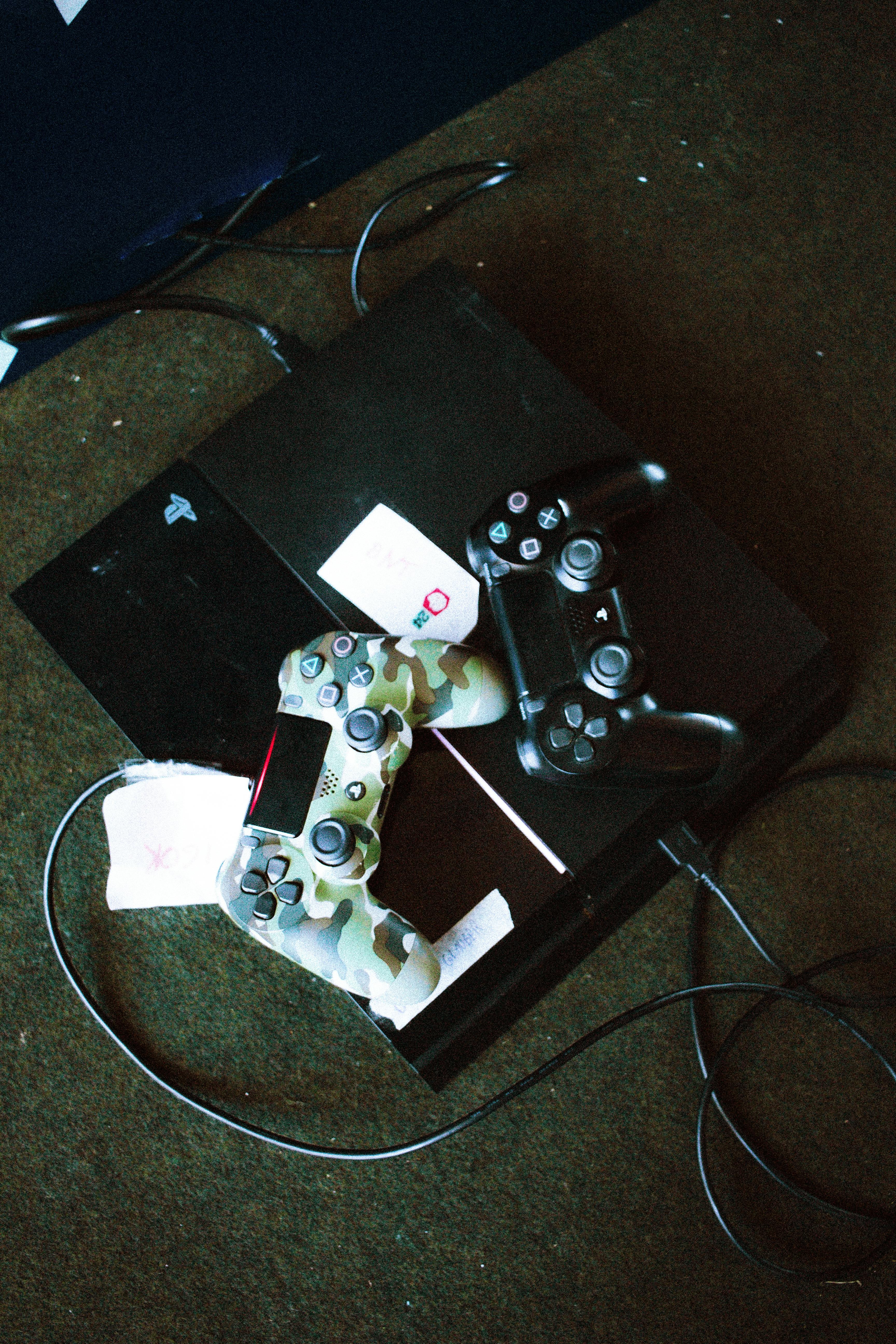 Gaming Console with DualShock Controllers on Floor · Free Stock Photo