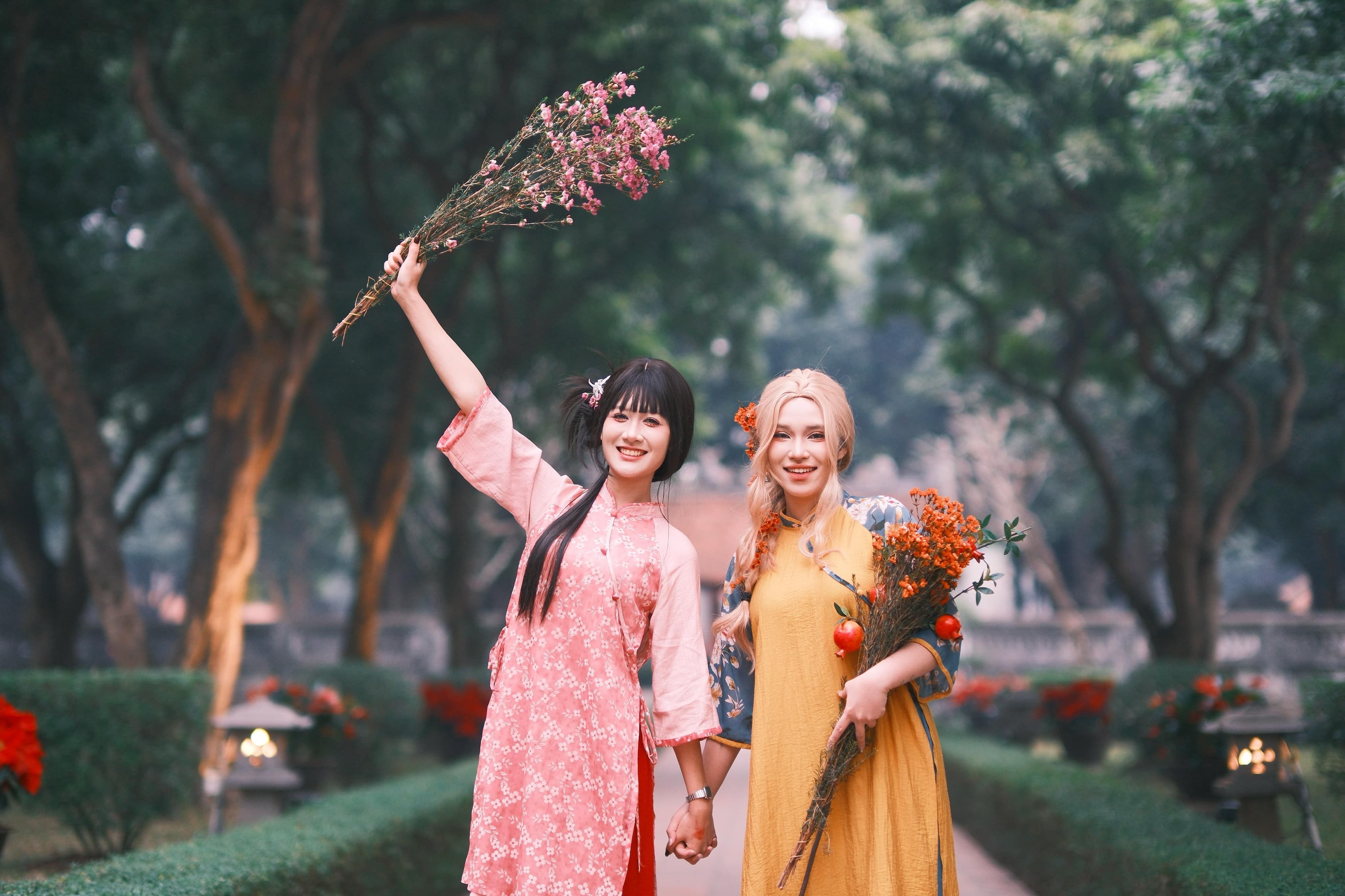 Two Women Celebrating Friendship in Vibrant Garden · Free Stock Photo